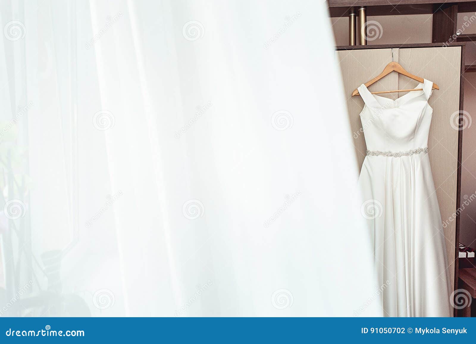 Simple White Wedding Dress on the Rack at the Wardrobe Stock Photo ...