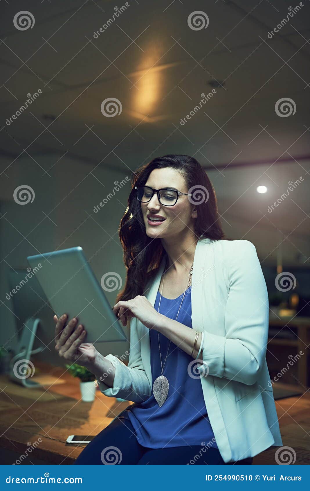 Simplifying Tasks with Technology. a Young Businesswoman Working Late ...