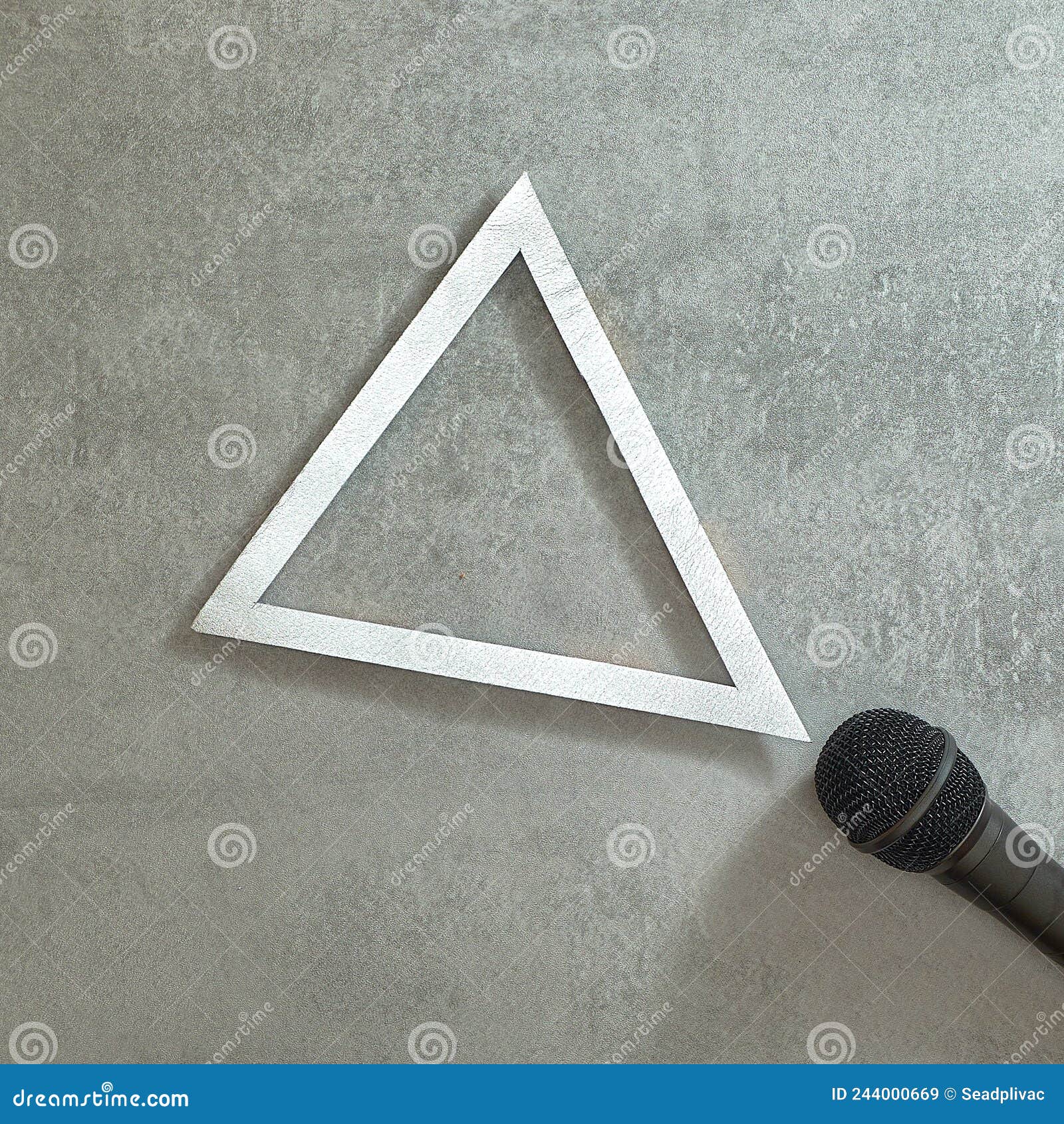 Simply. Microphone and Silver Triangle Frame on Gray Concrete ...
