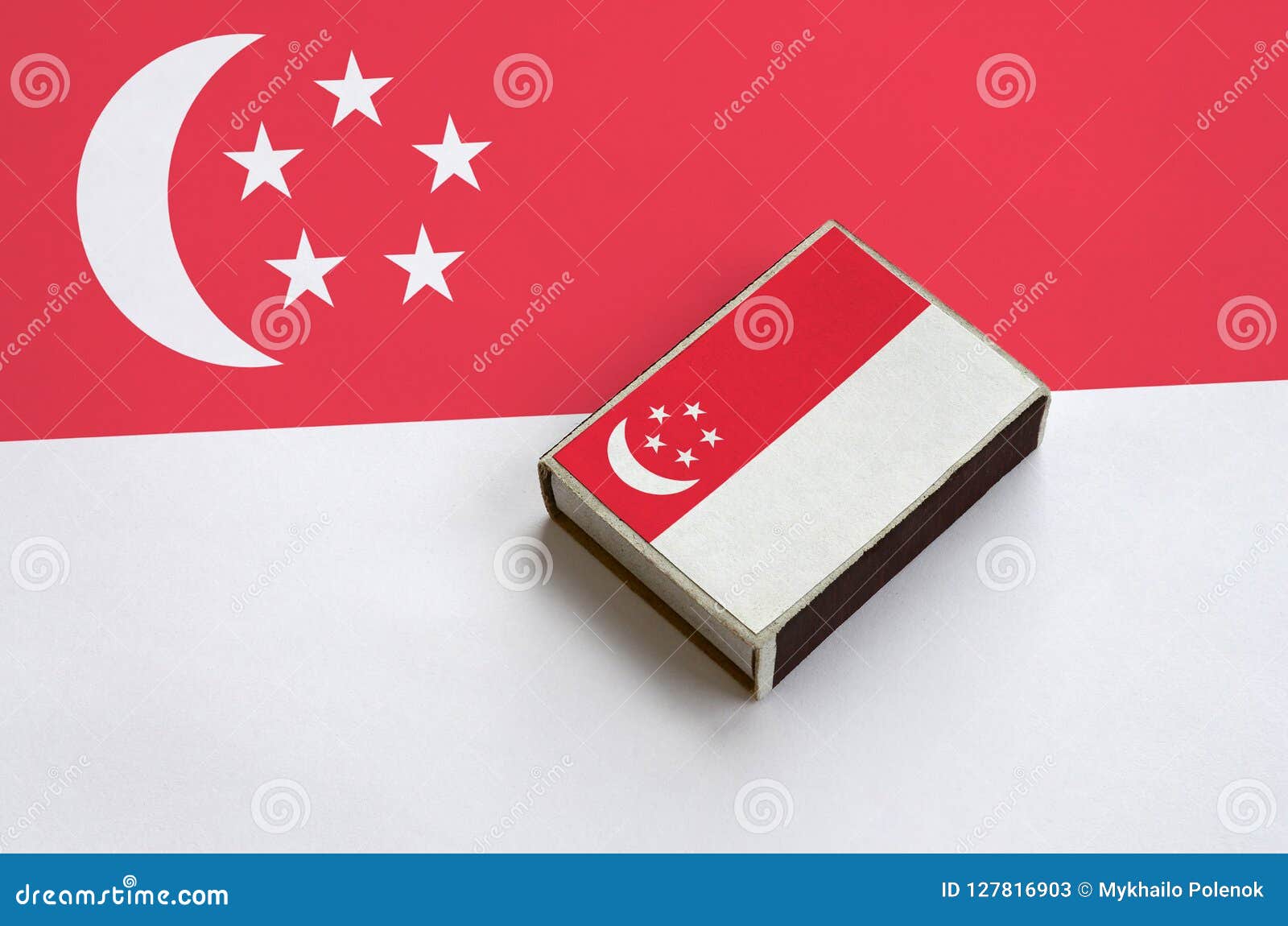 Singapore Flag is Pictured on a Matchbox that Lies on a Large Flag ...