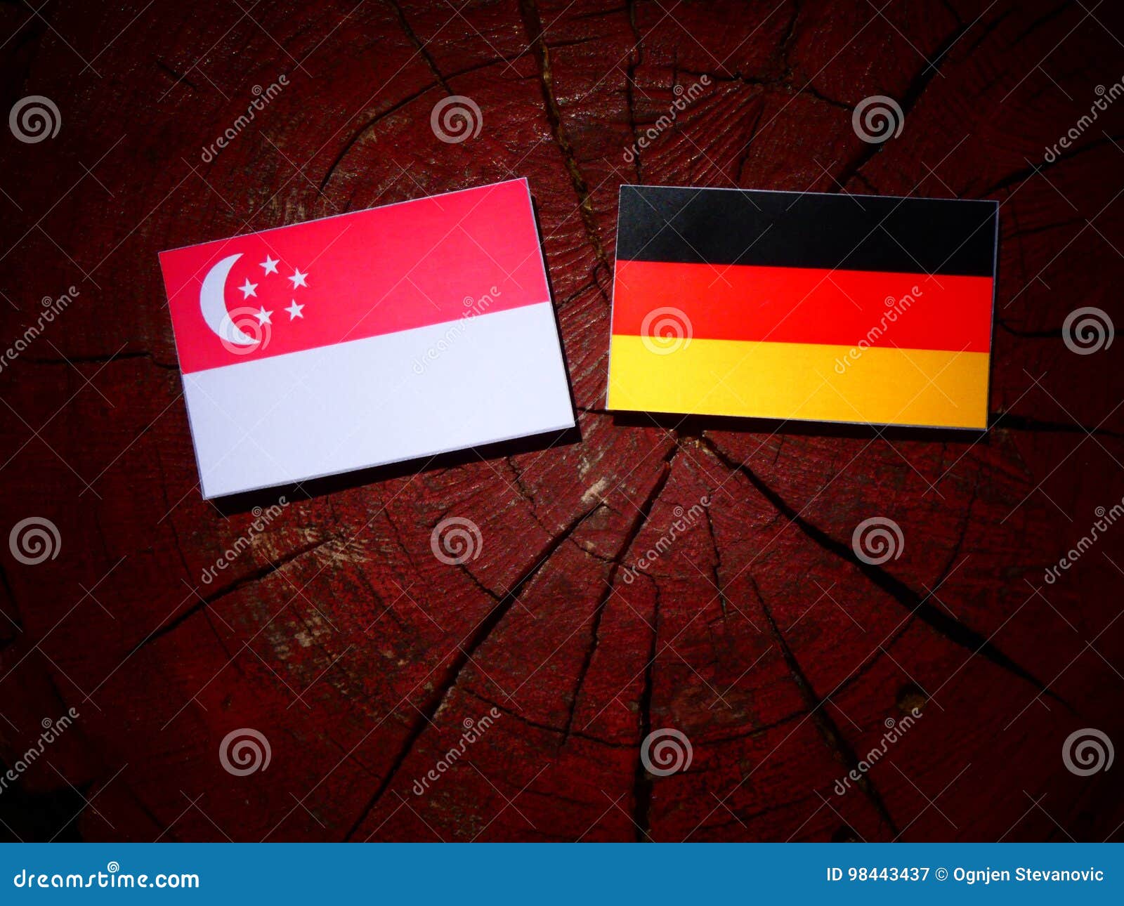 Singaporean Flag with German Flag on a Tree Stump Stock Image - Image ...