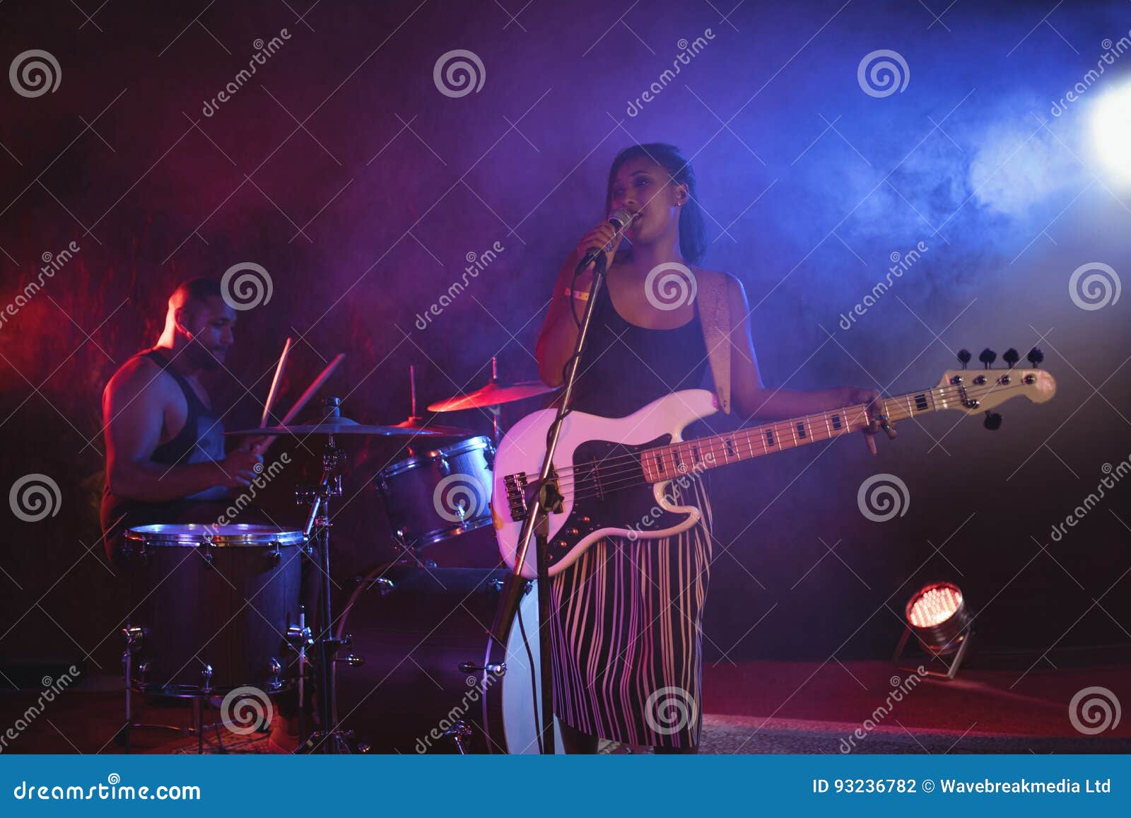 Confident Singer Performing With Coworker In Illuminated Nightclub ...