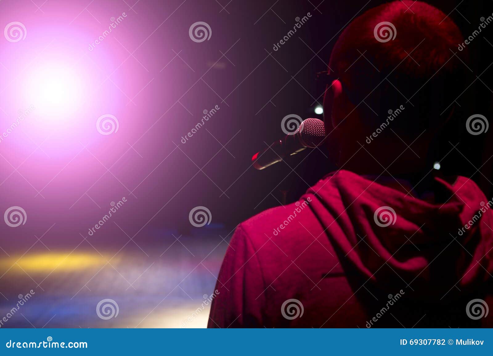 Singer Holding a Microphone and Singing Stock Photo - Image of length ...