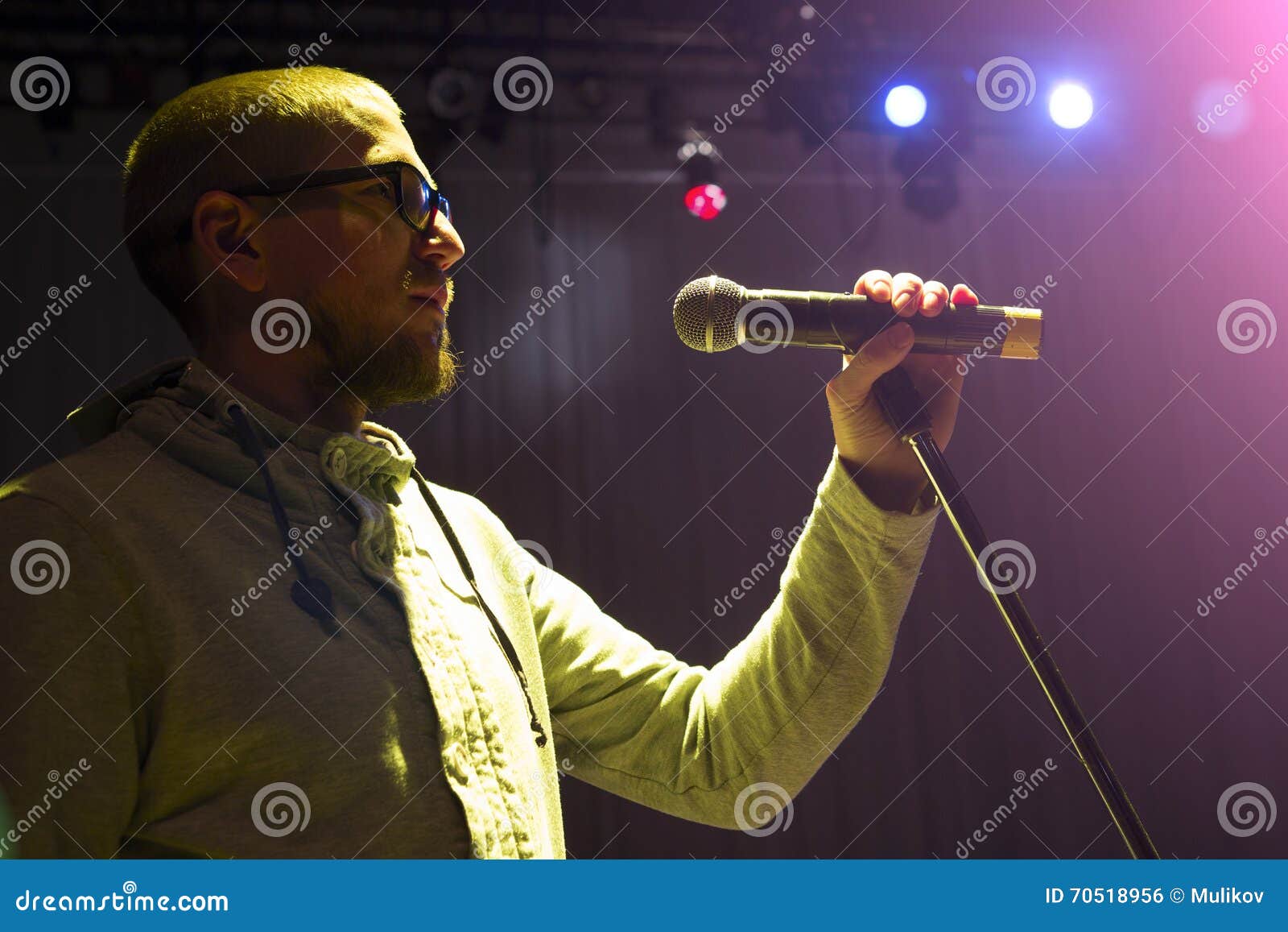 Singer Holding a Microphone and Singing Stock Photo - Image of ...