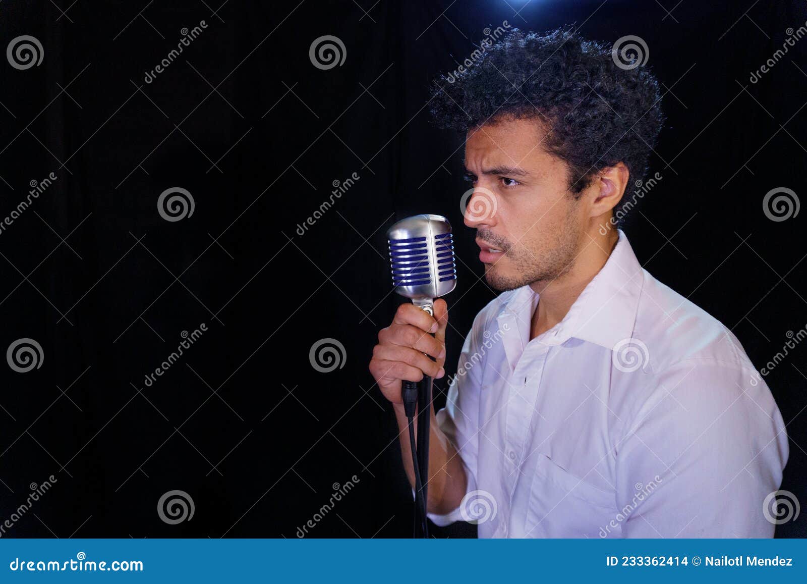 Singer Holding a Microphone Stand and Performing on Stage Stock Photo ...