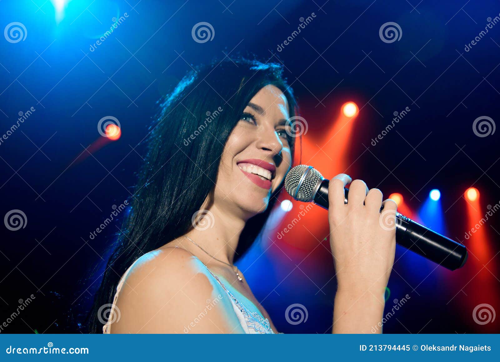 Singer with Microphone on the Colorful Light Stage Background Stock ...