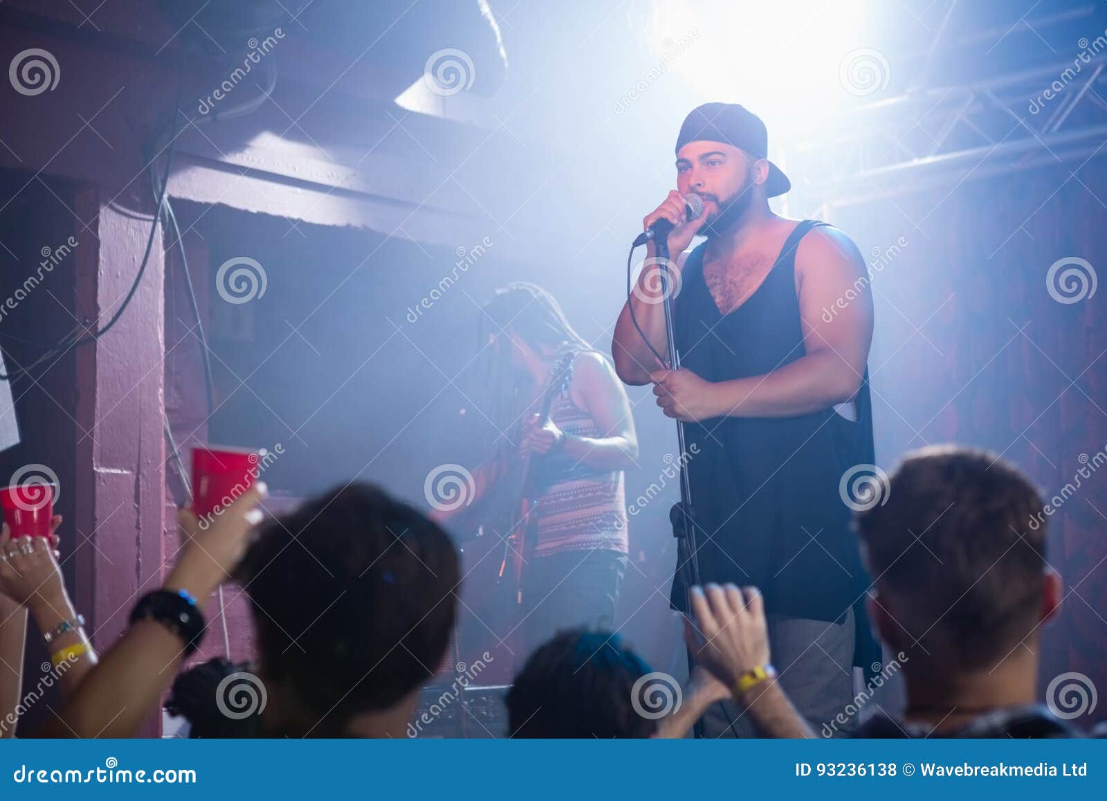 Singer performing on stage stock photo. Image of concert - 93236138