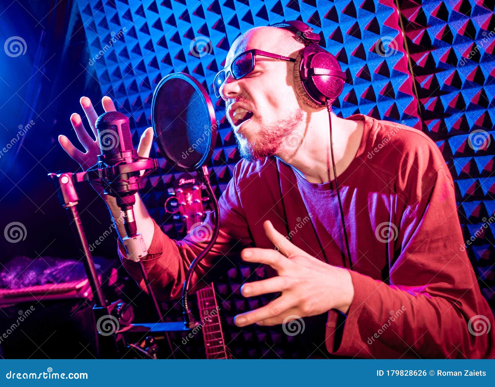 The Singer Sings with a Microphone in the Recording Studio. Stock Photo ...