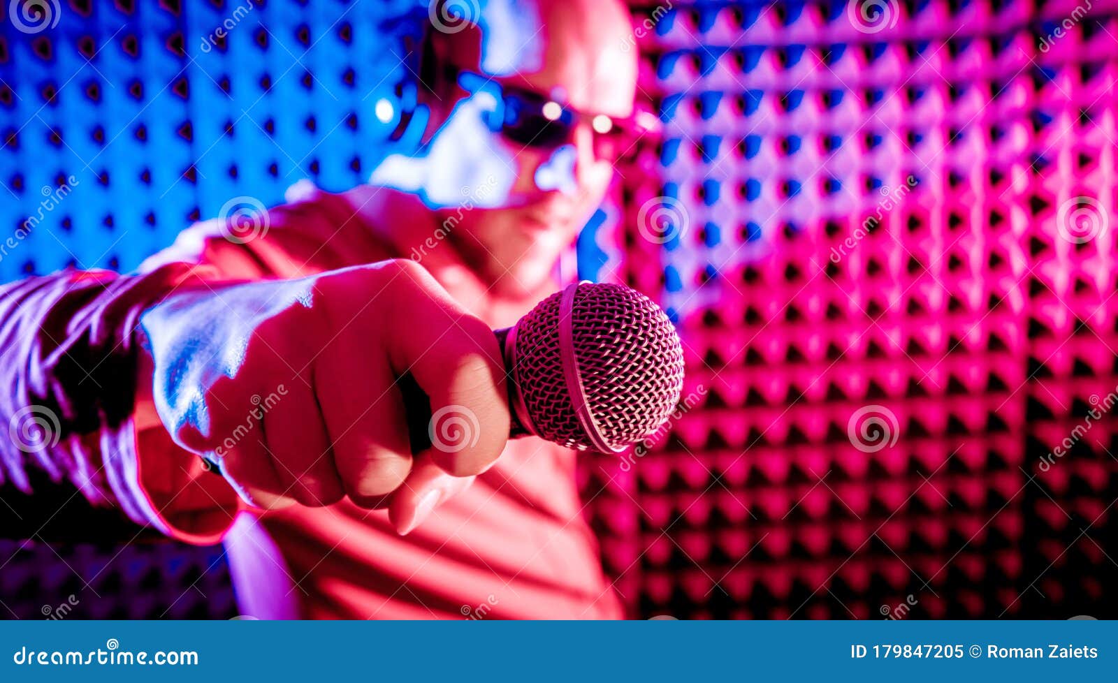 The Singer Sings with a Microphone in the Recording Studio. Stock Image ...