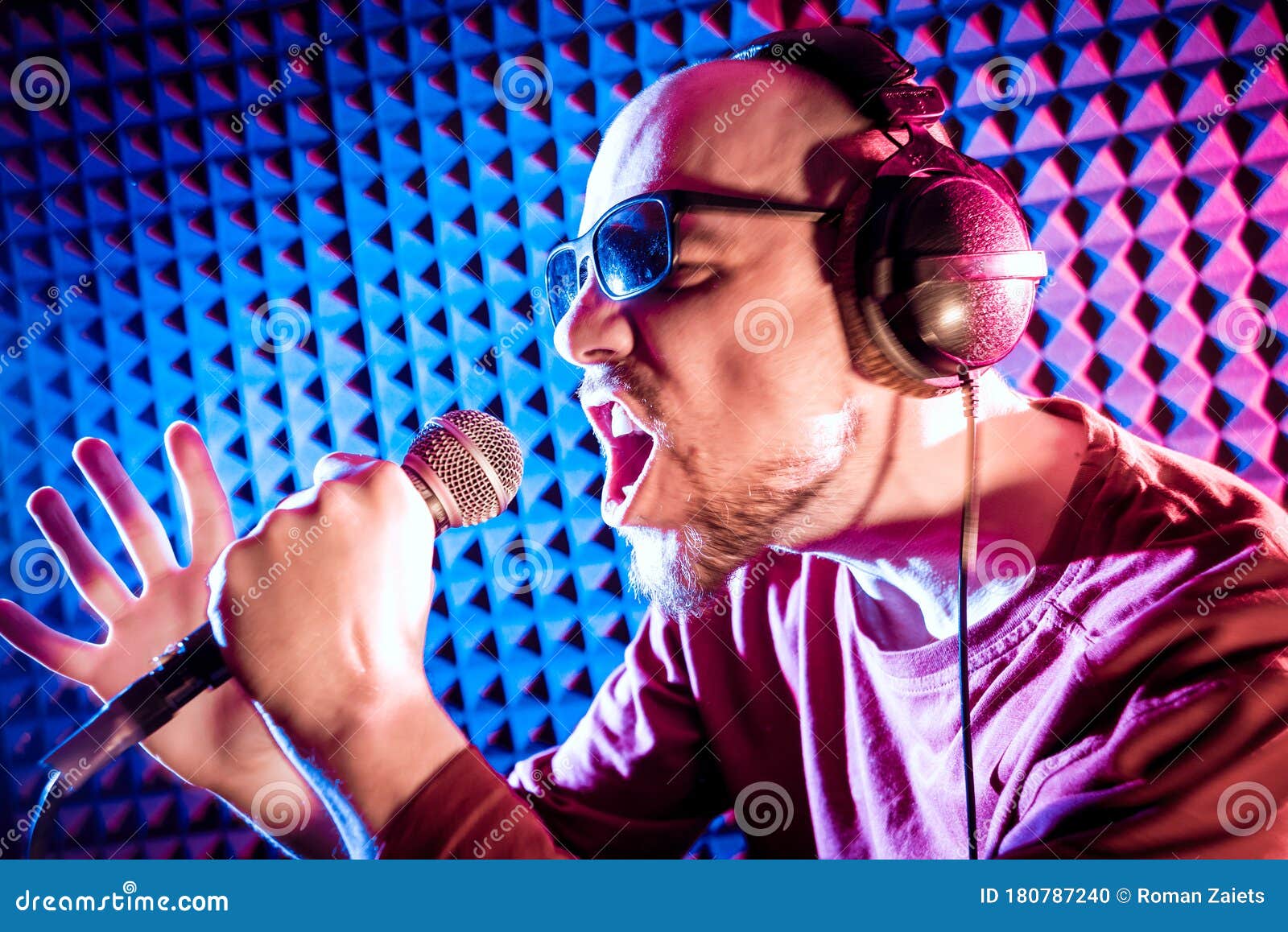 The Singer Sings with a Microphone in the Recording Studio. Stock Photo ...