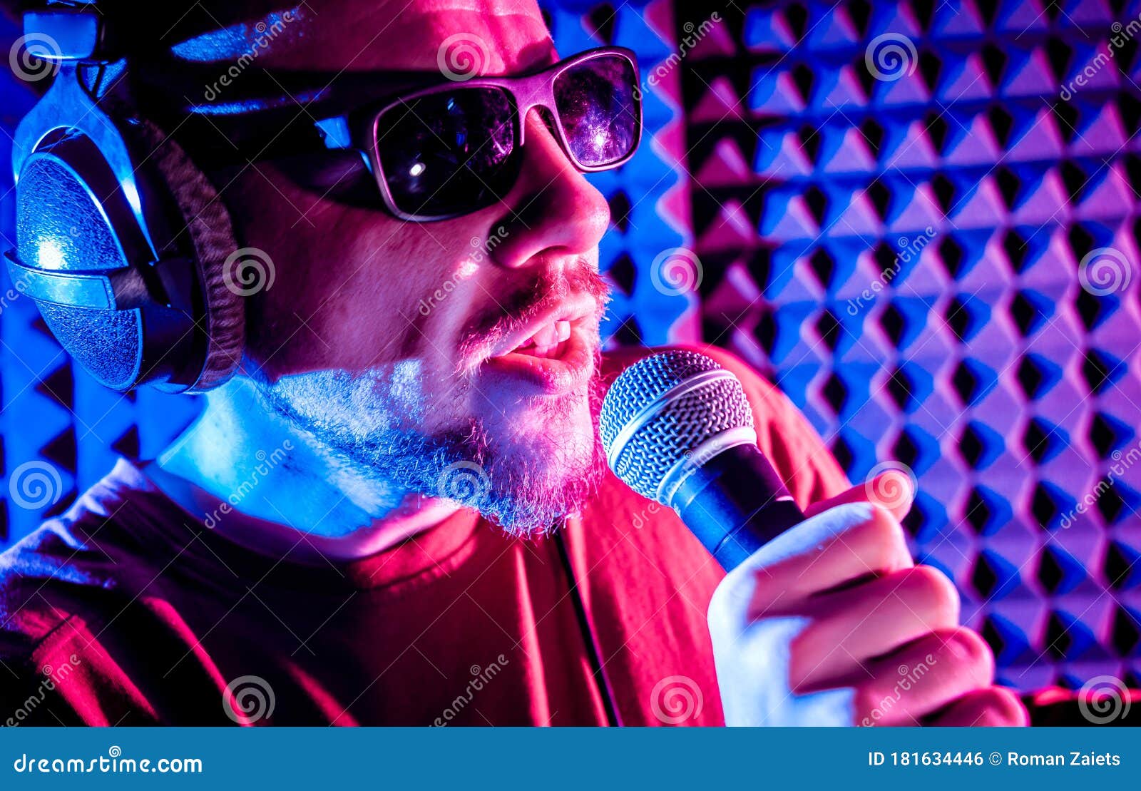 The Singer Sings with a Microphone in the Recording Studio. Stock Photo ...
