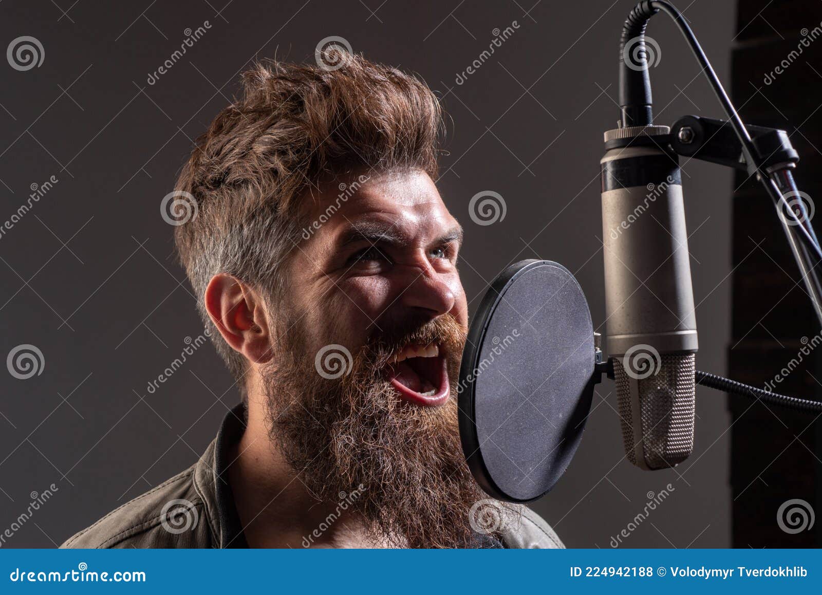 Singing Man in a Recording Studio. Expressive Bearded Man with ...