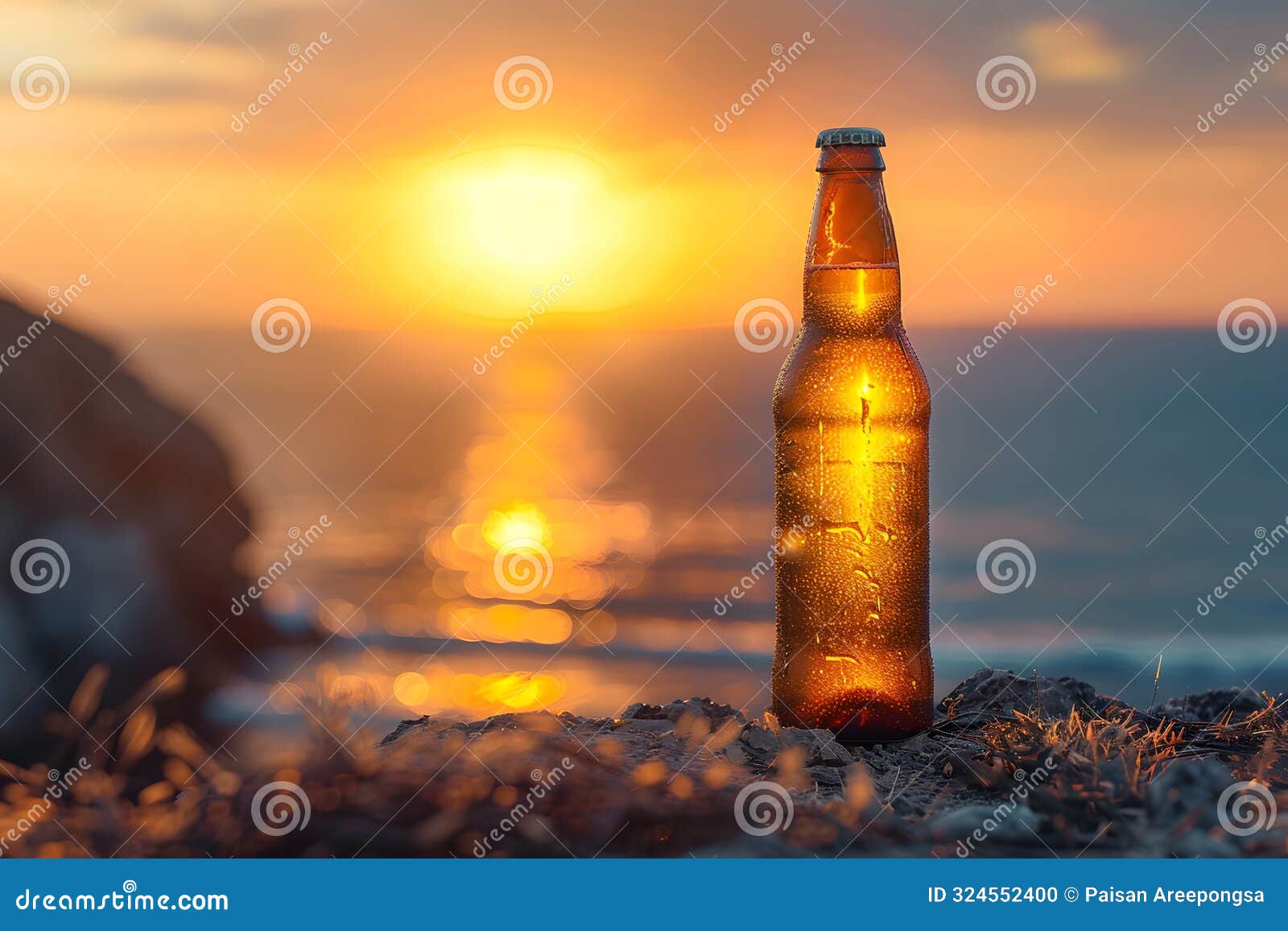 A Single Beer Bottle with a Sunset in the Background Stock Photo ...
