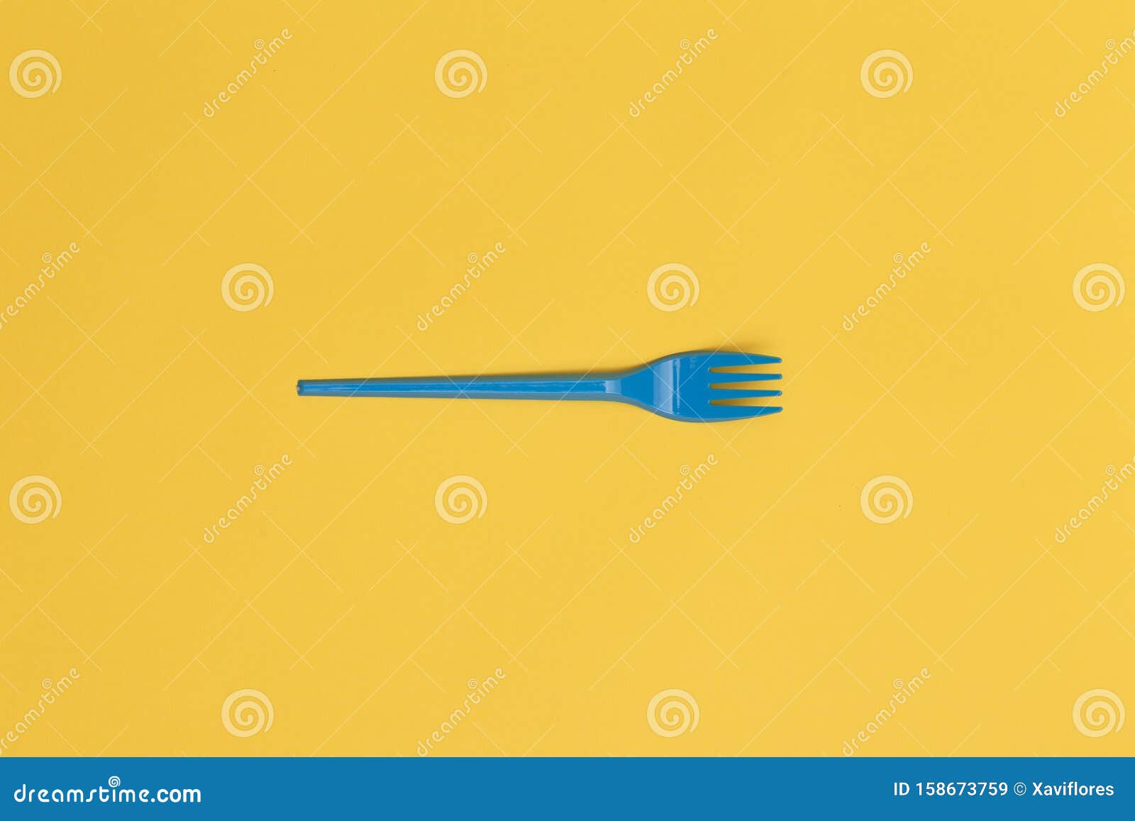 Single Blue Disposable Fork Over a Yellow Background Stock Image ...