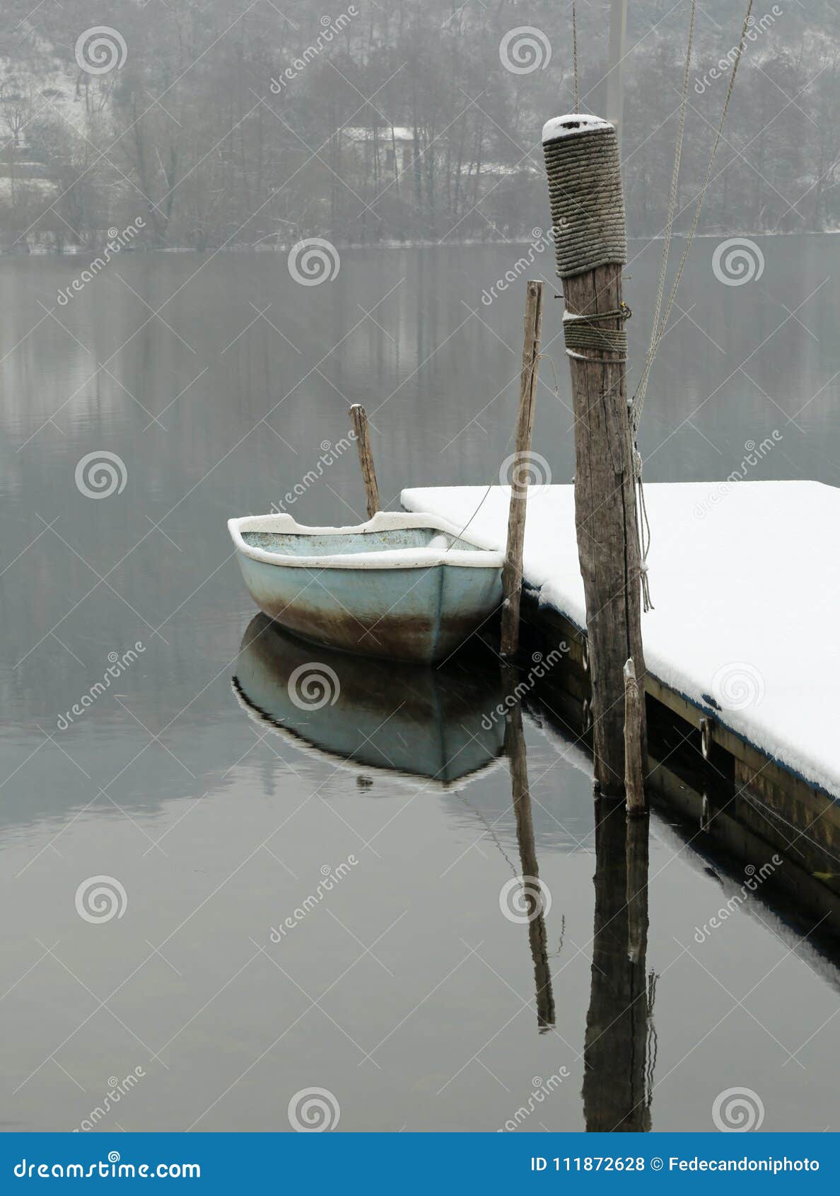Boat on the lake with snow stock photo. Image of reflect - 111872628