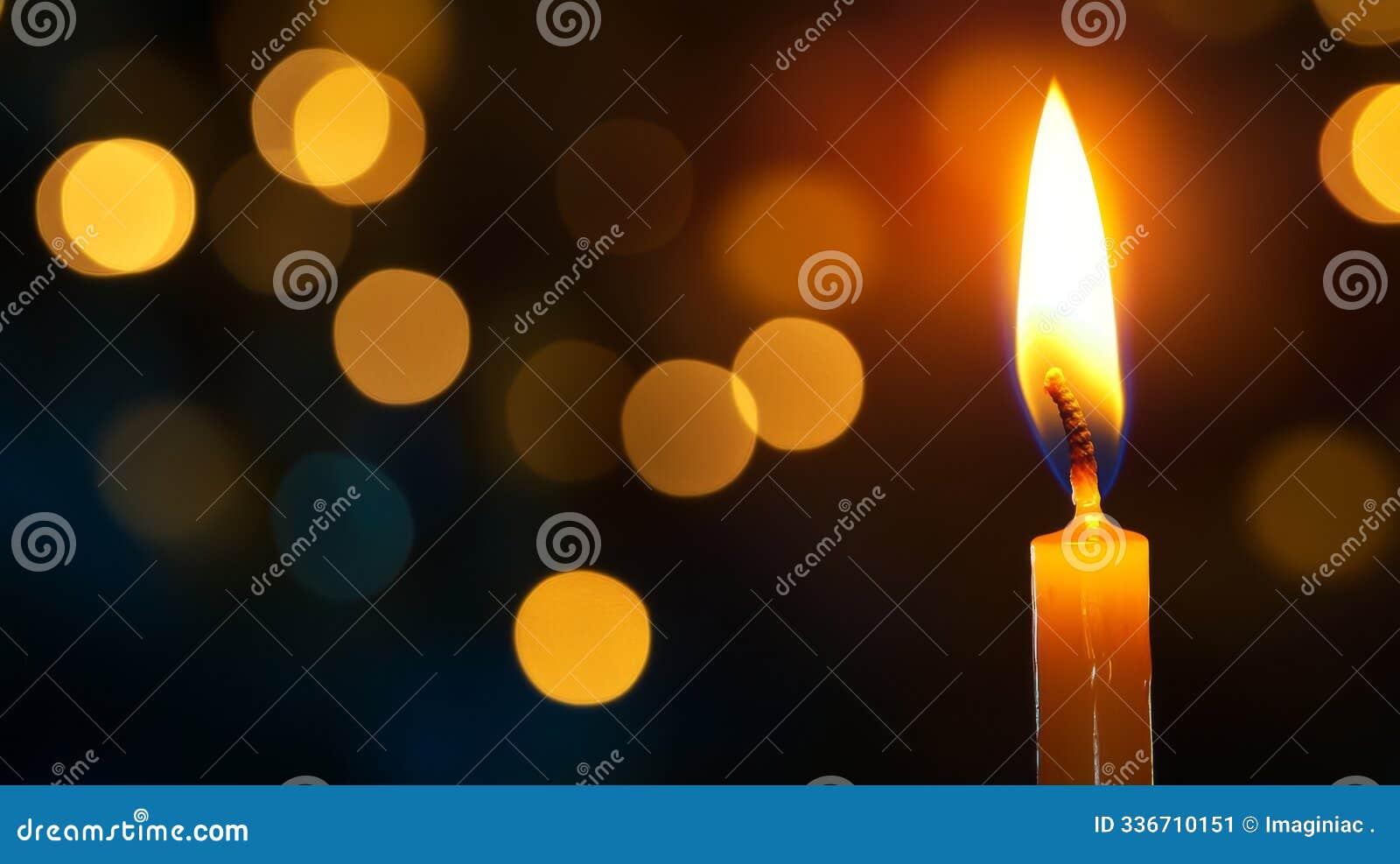 A Single Candle Flame with Defocused Lights in the Background Stock ...