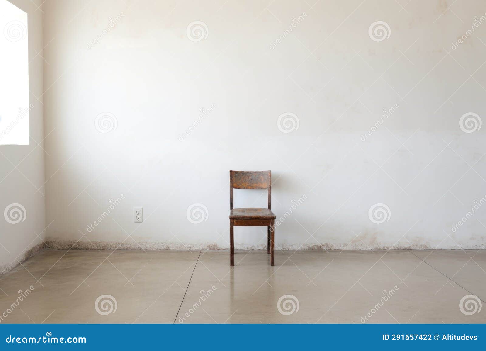 A Single Chair in an Empty Room with Stark White Walls Stock Photo ...
