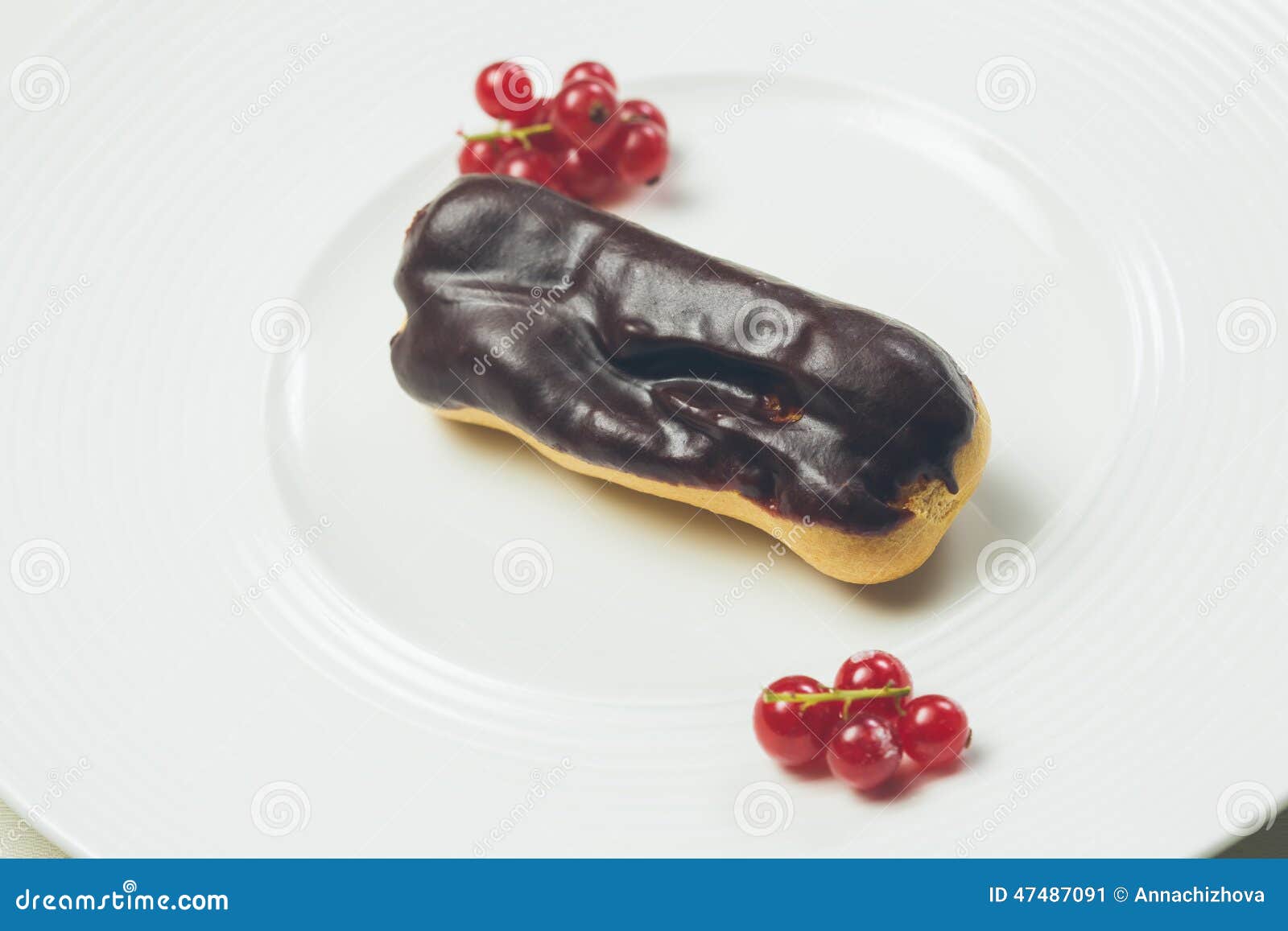 Single Chocolate Eclair on White Plate Stock Image - Image of ...