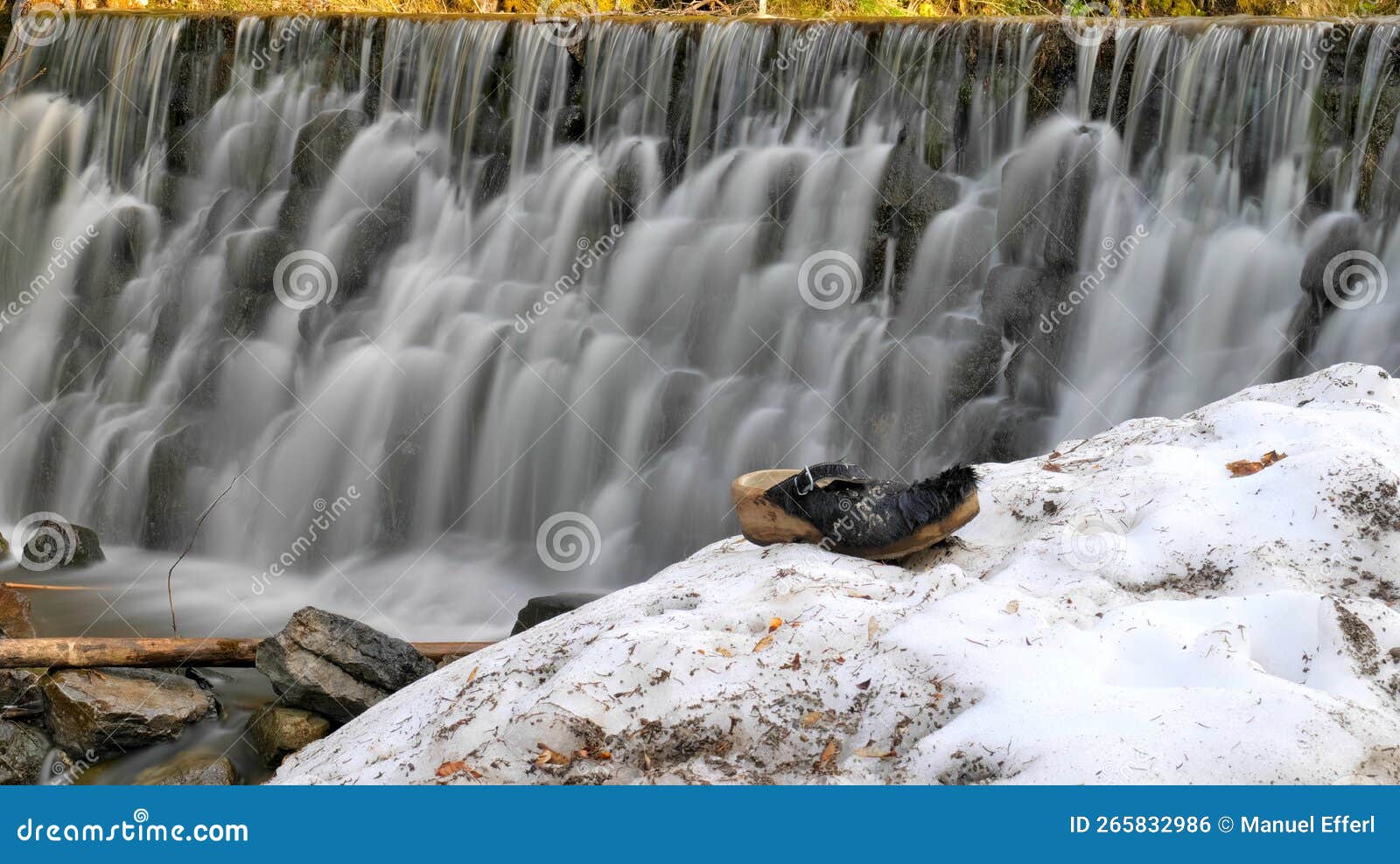 Single Clog on Snow Pile in Front of Waterfall with Many Steps Stock ...