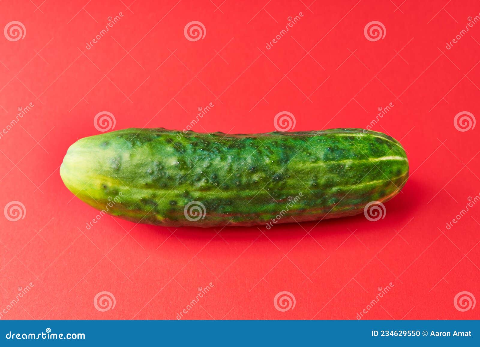 Single Cucumber on a Red Background Stock Photo - Image of food, single ...