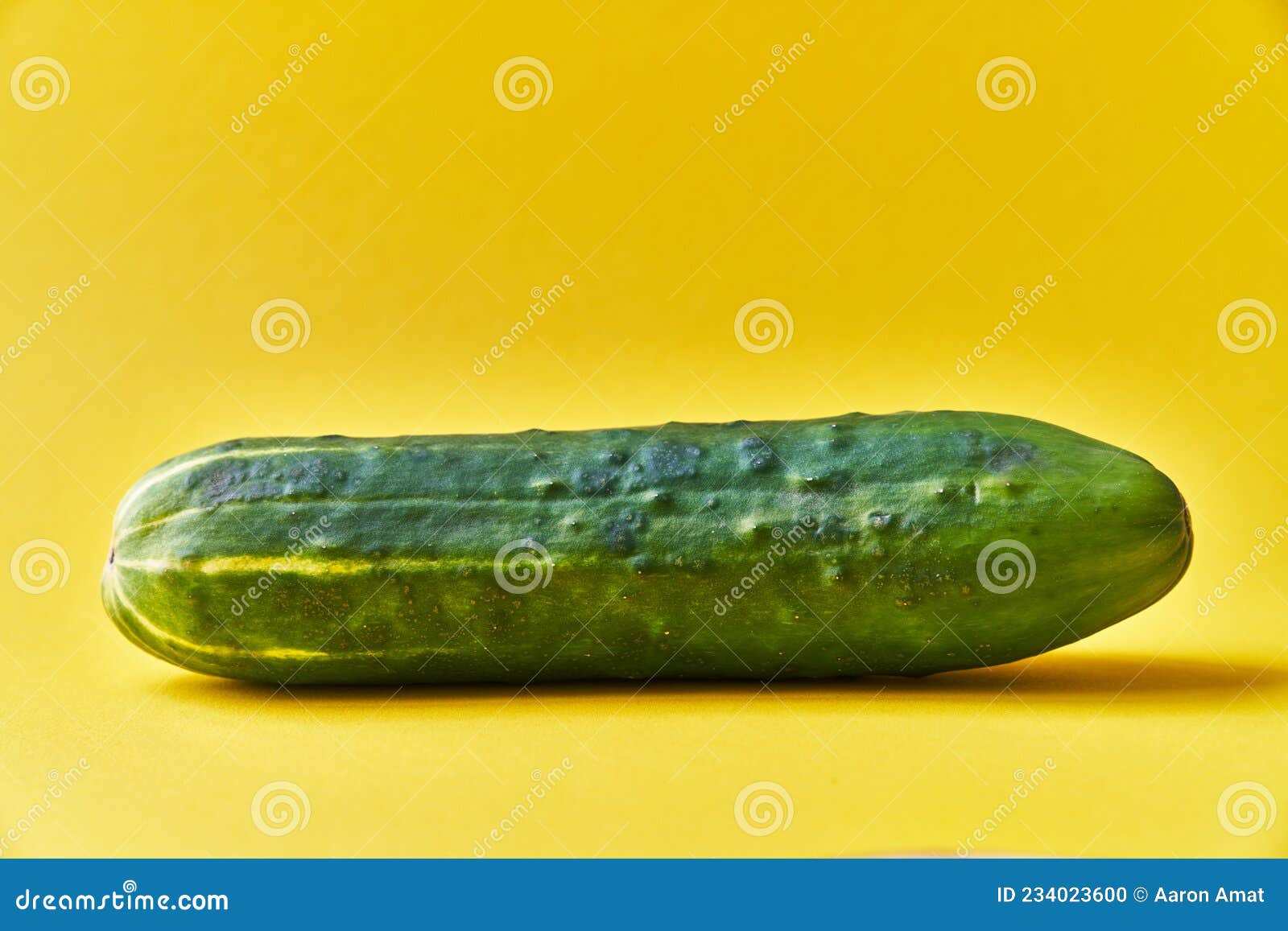 Single Cucumber on a Yellow Background Stock Photo - Image of vegetable ...