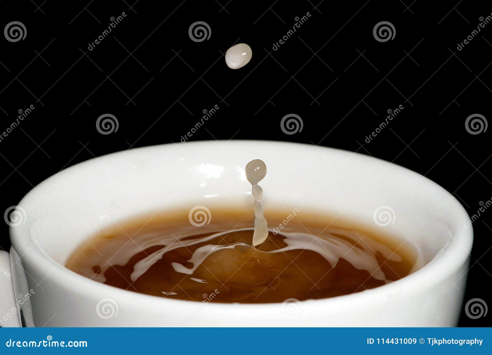 Single Droplet of Milk Falling into a Cup of Coffee Stock Image - Image ...