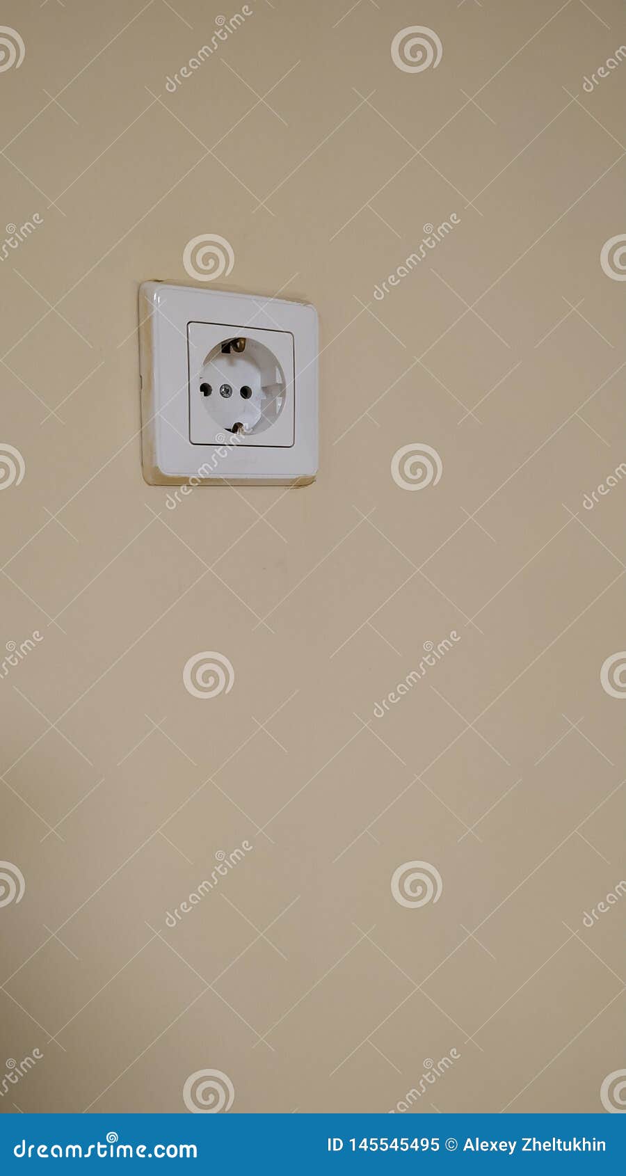Single Electrical Outlet on the Wall Painted in Beige Color. Close-up ...
