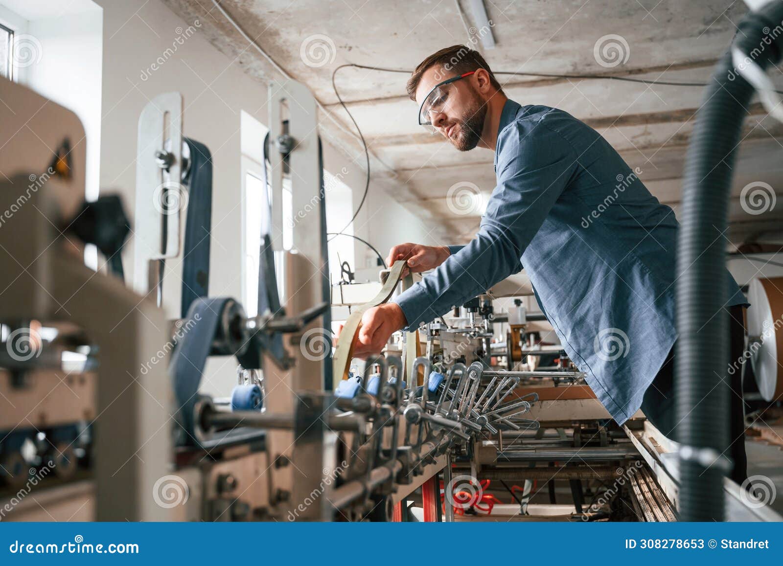 Single Employee. Handsome Man is Working at the Factory of Creating Eco ...