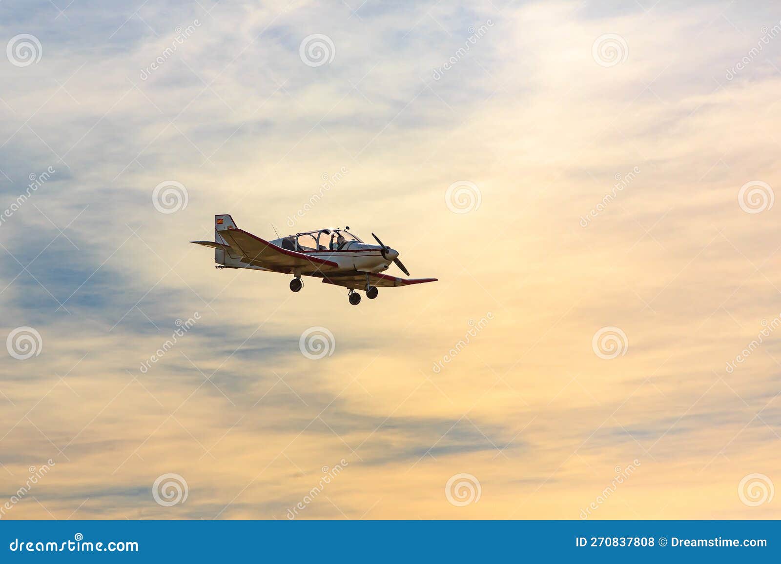 Single-engine Airplane Flies Against the Backdrop of Sunset and the ...