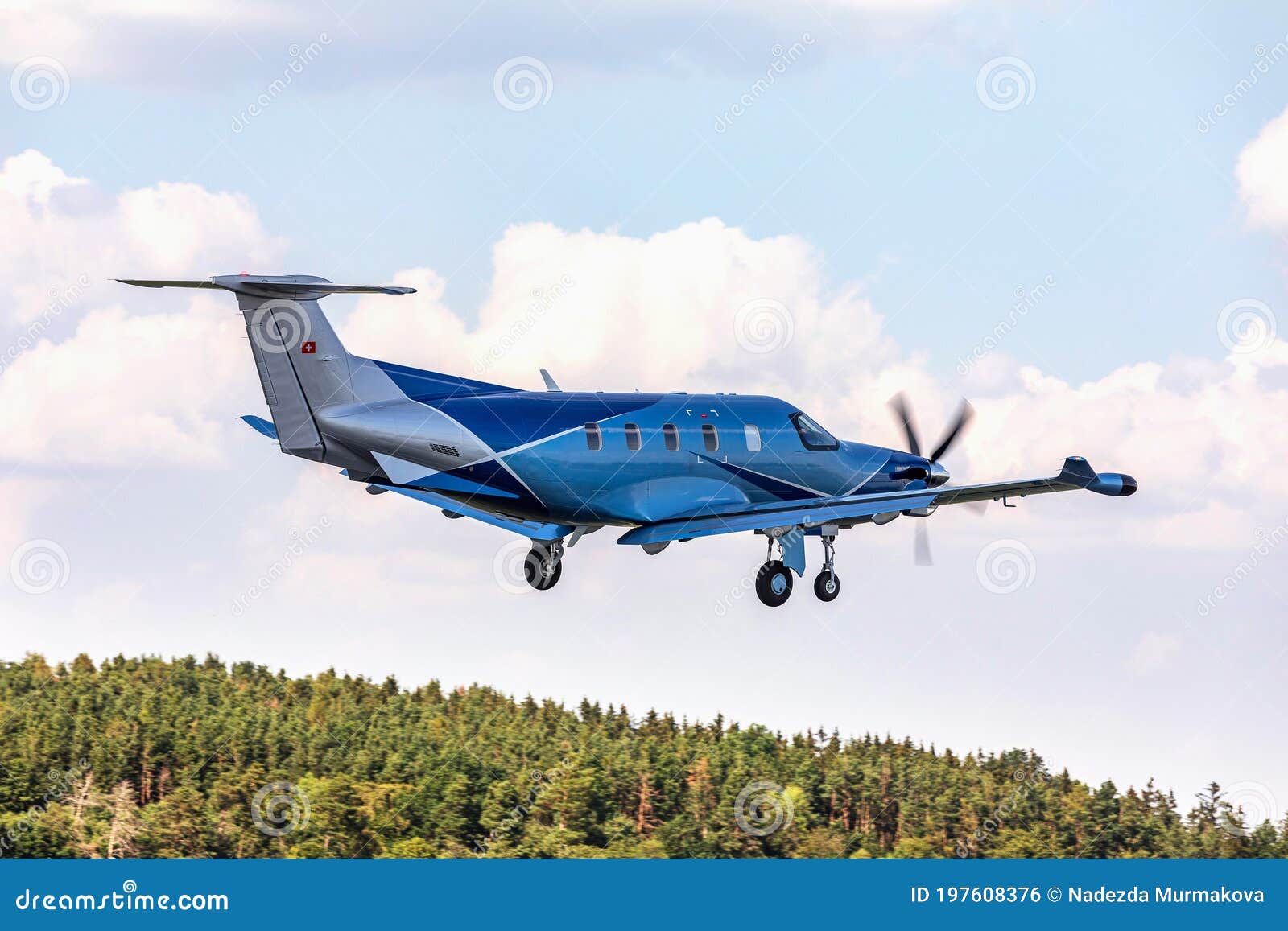 Single-engine Blue Airplane Flying on a Sunny Day in the Blue Sky. the ...