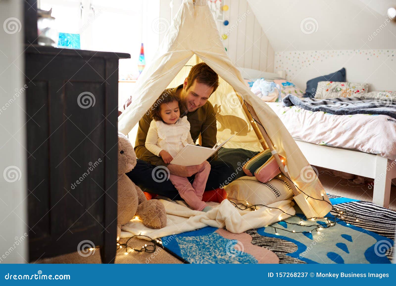 Single Father Reading with Daughter in Den in Bedroom at Home Stock ...