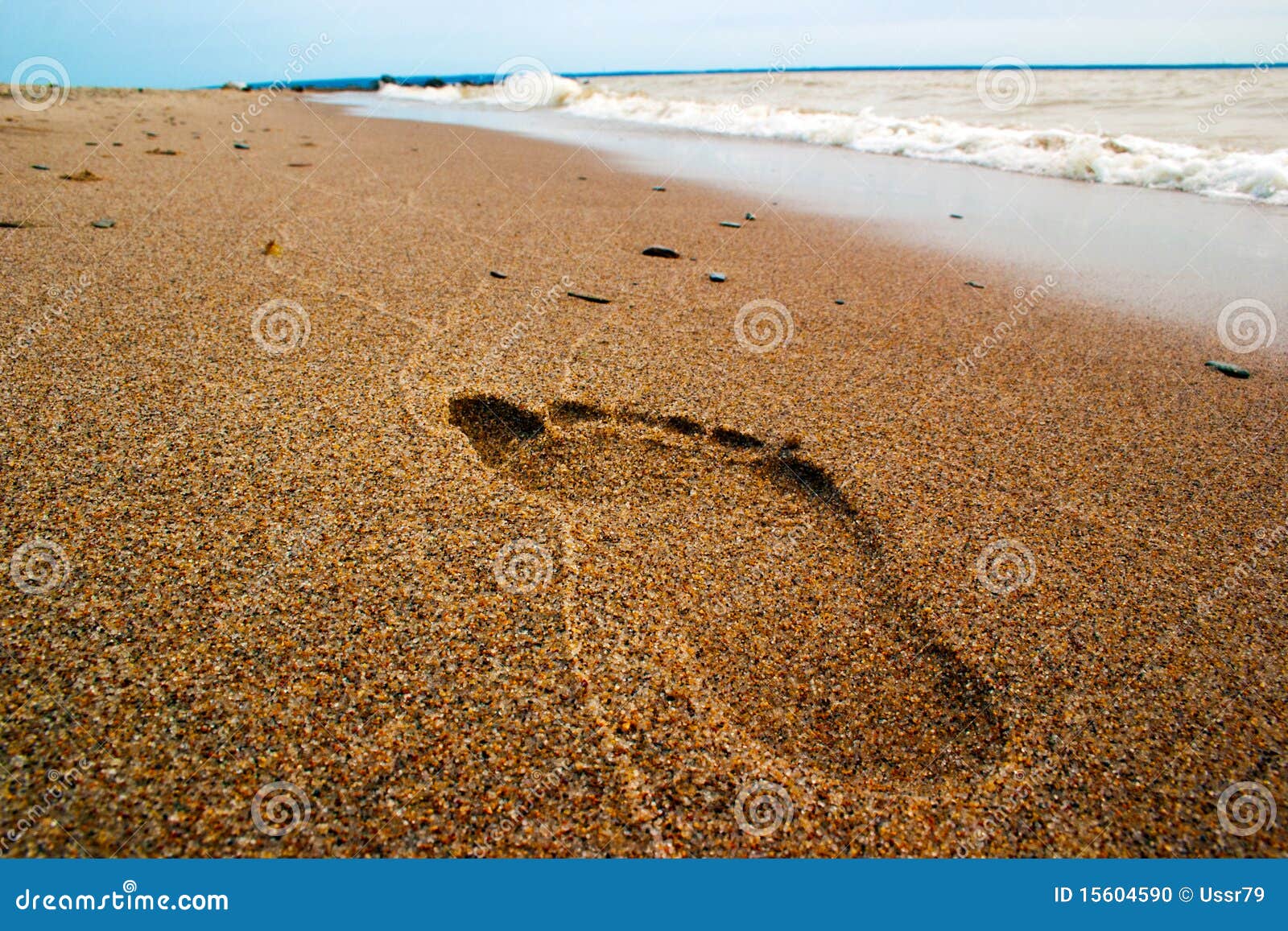 Single Footprint Of Bare Feet On Yellow Sand. Shiny Foot Imprint In ...