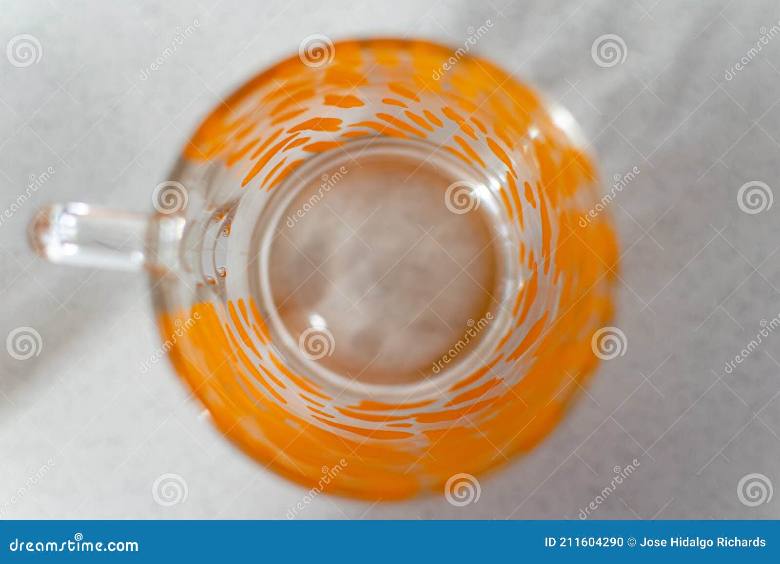 Single Glass Cup with a Orange Pattern from Above Stock Photo - Image ...