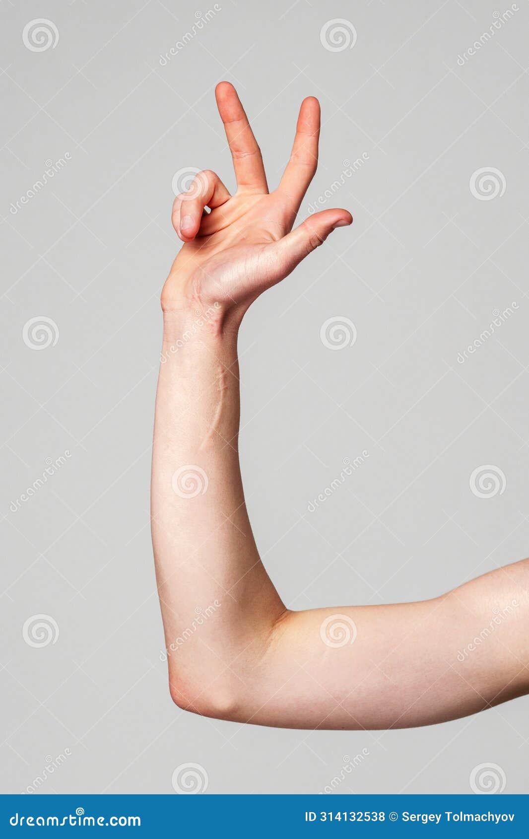 Elevated Bare Human Arm Bent at the Elbow Against a Neutral Background ...