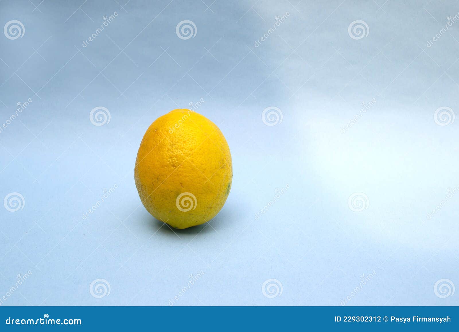 Single Lemon Fruit on Blue Background and Light Shadow Stock Photo ...