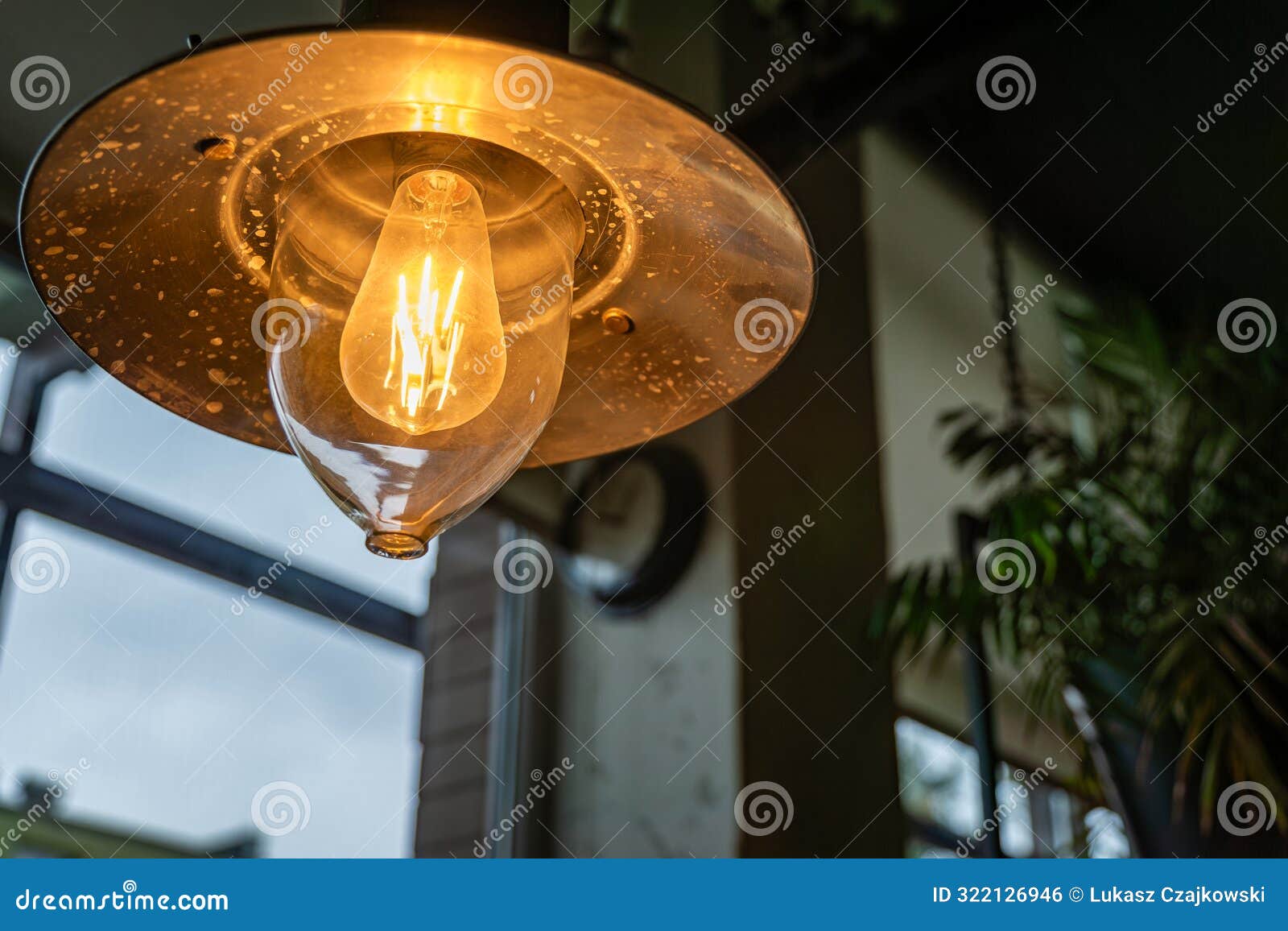 A Single Light Bulb Hanging in a Restaurant Interior Stock Photo ...