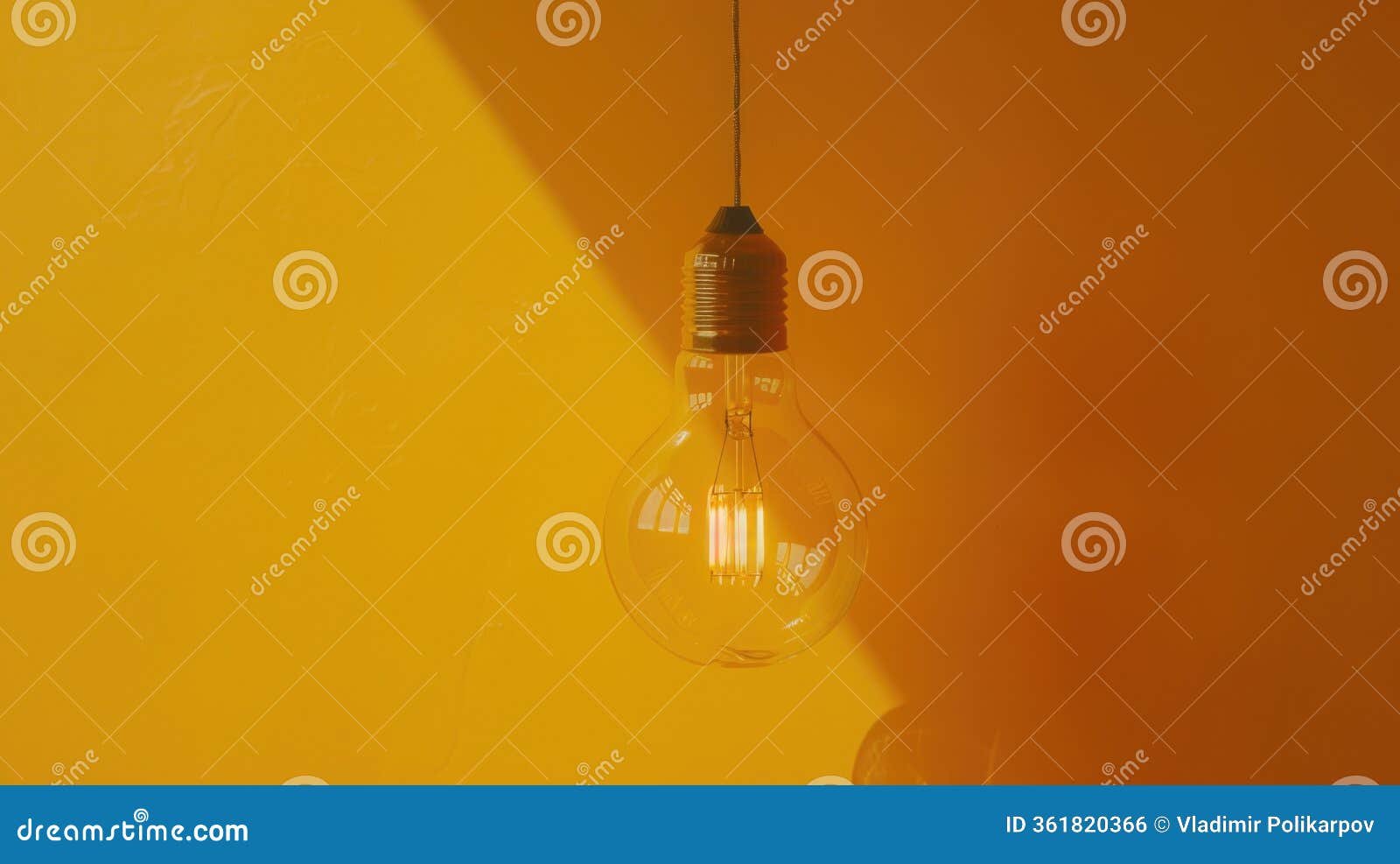 A Single Light Bulb Hanging from a Yellow Wall. Perfect for Interior ...