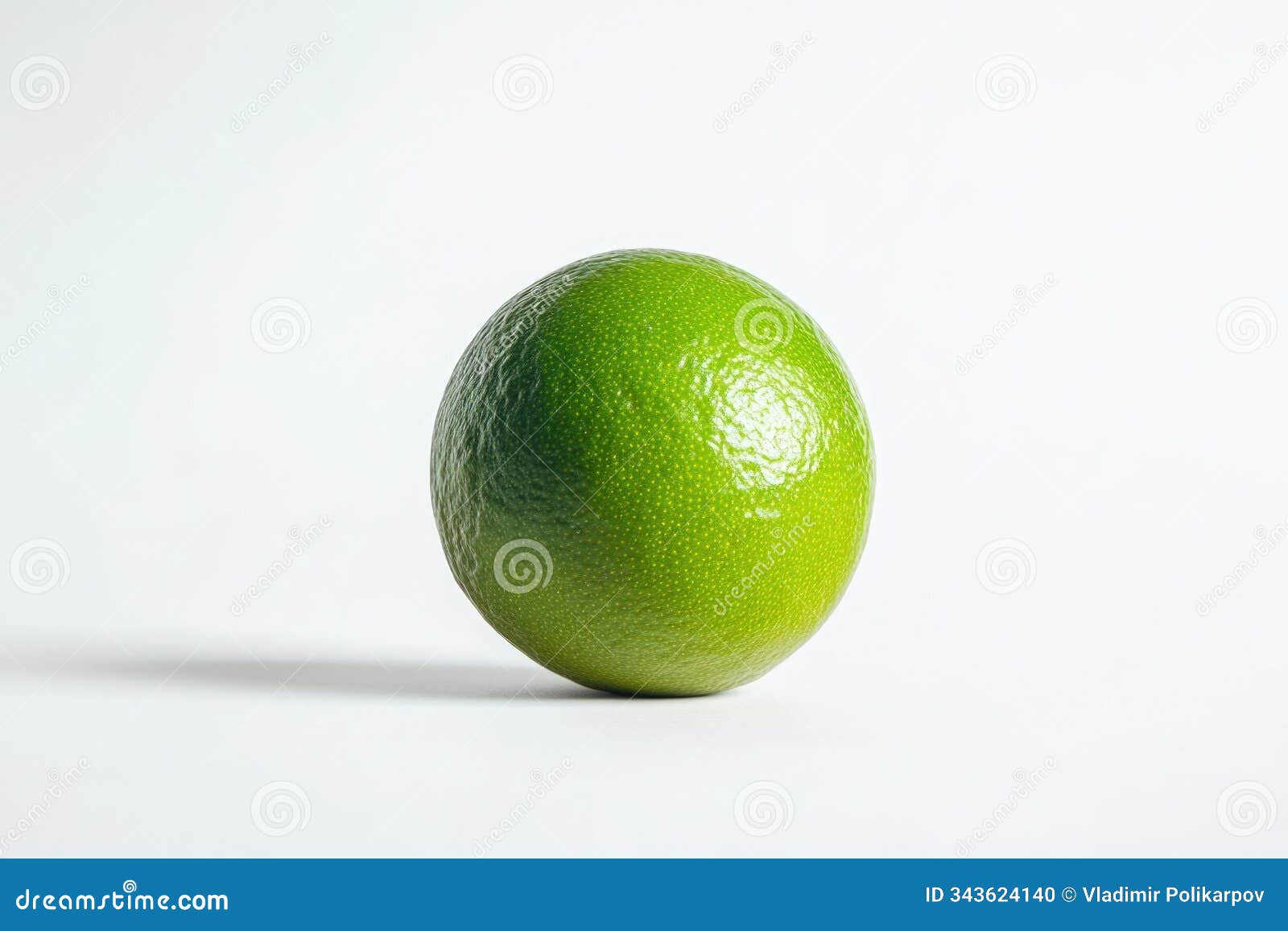 A Single Lime Sitting on a White Surface with a Shadow Stock Photo ...
