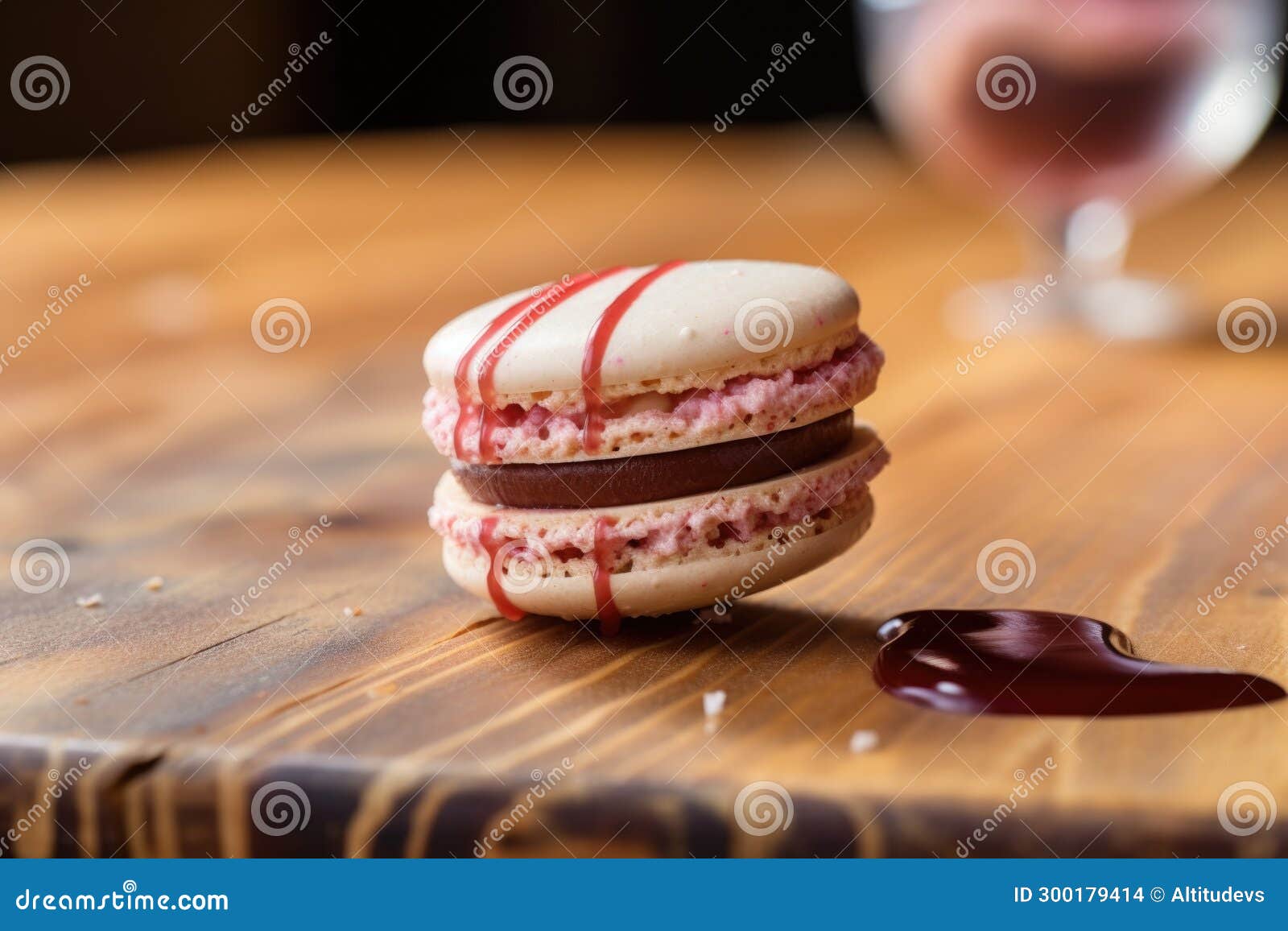 A Single Macaron with a Bite Taken Out on a Wooden Table Stock Photo ...