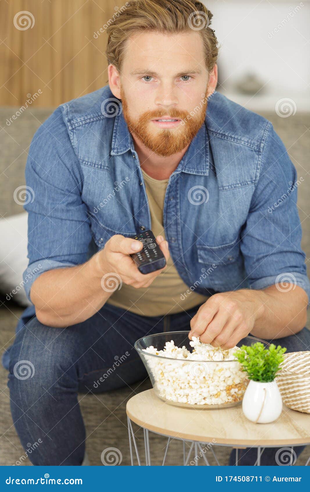 Single Man Holding Remote Control and Eating Popcorn Stock Image ...