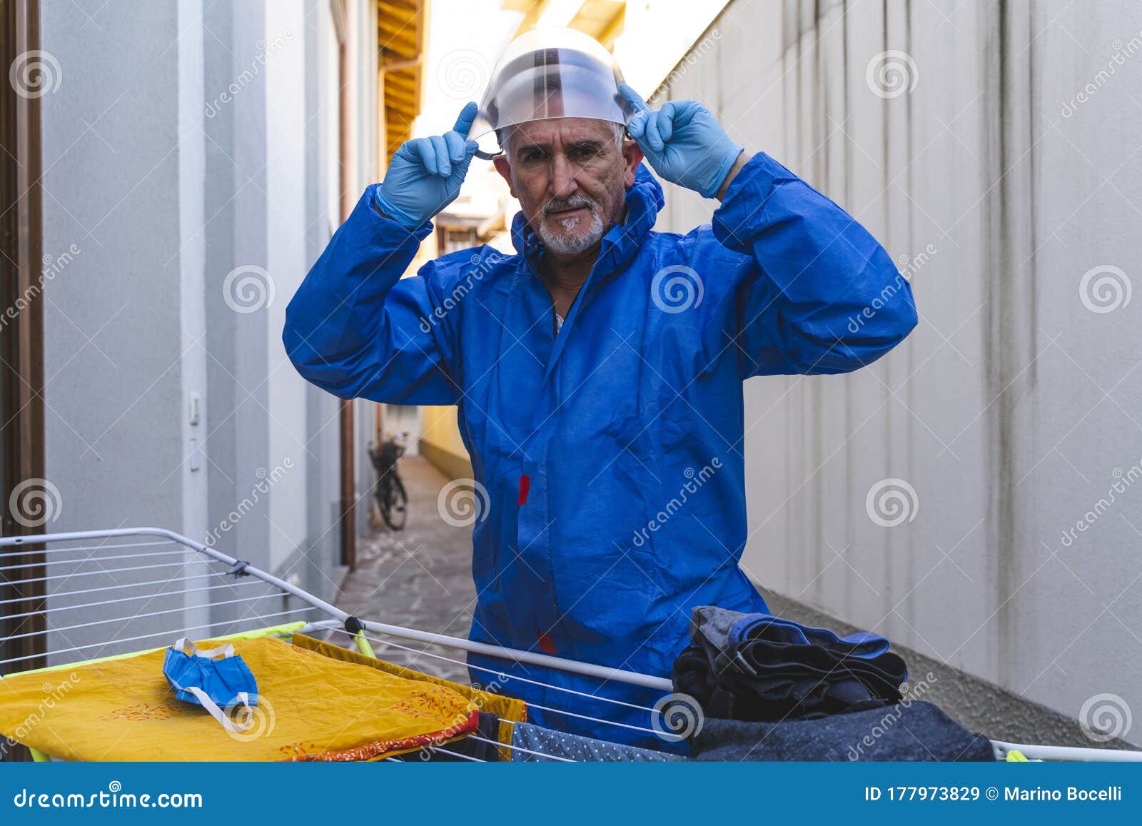 Single Man in Quarantine Dressed in Protective Suit is Doing Laundry ...