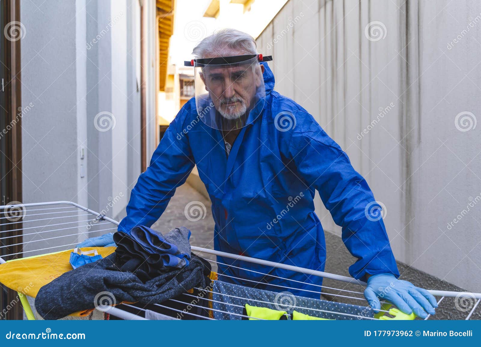 Single Man in Quarantine Dressed in Protective Suit is Doing Laundry ...