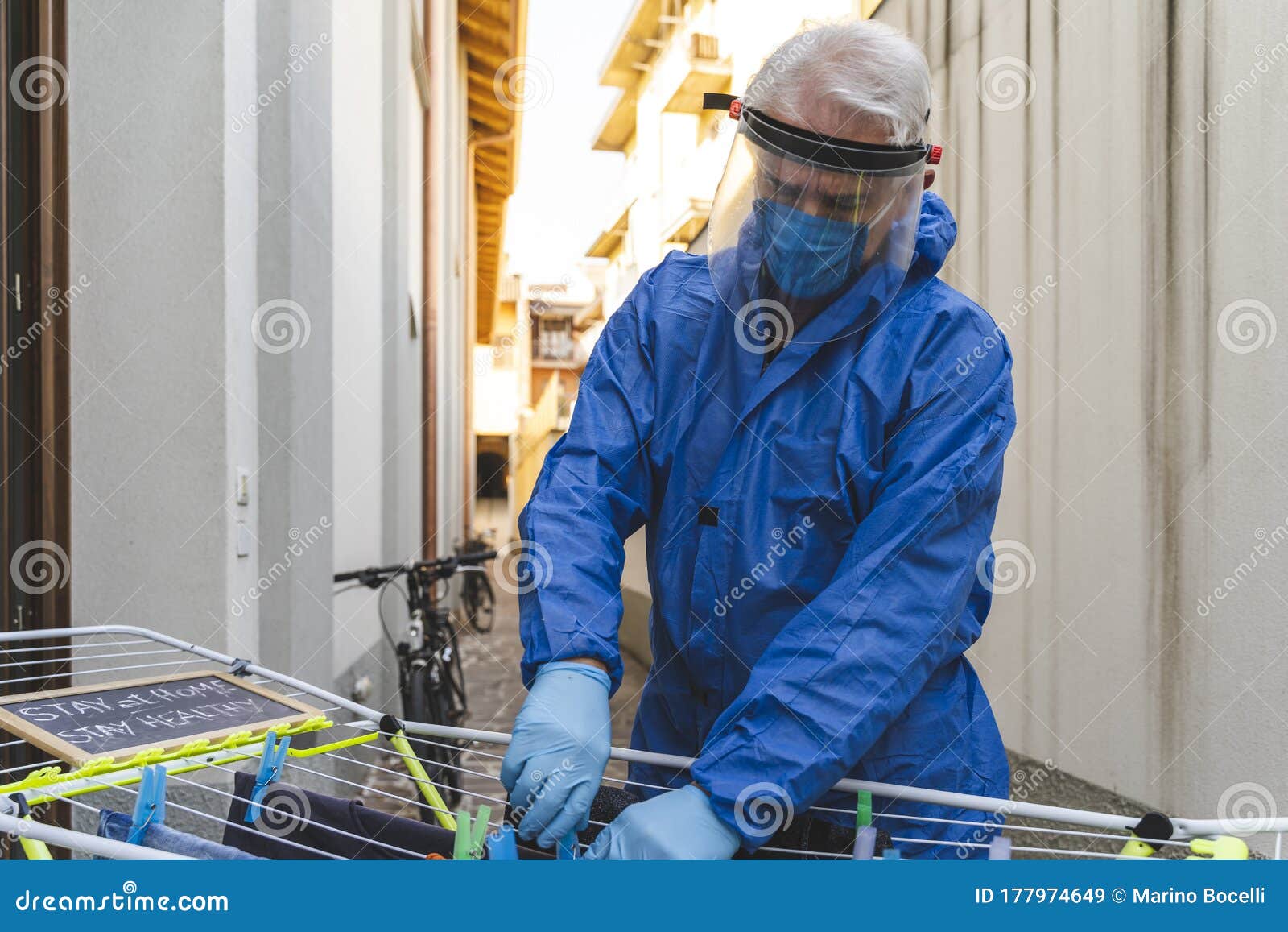 Single Man in Quarantine Dressed in Protective Suit is Doing Laundry ...