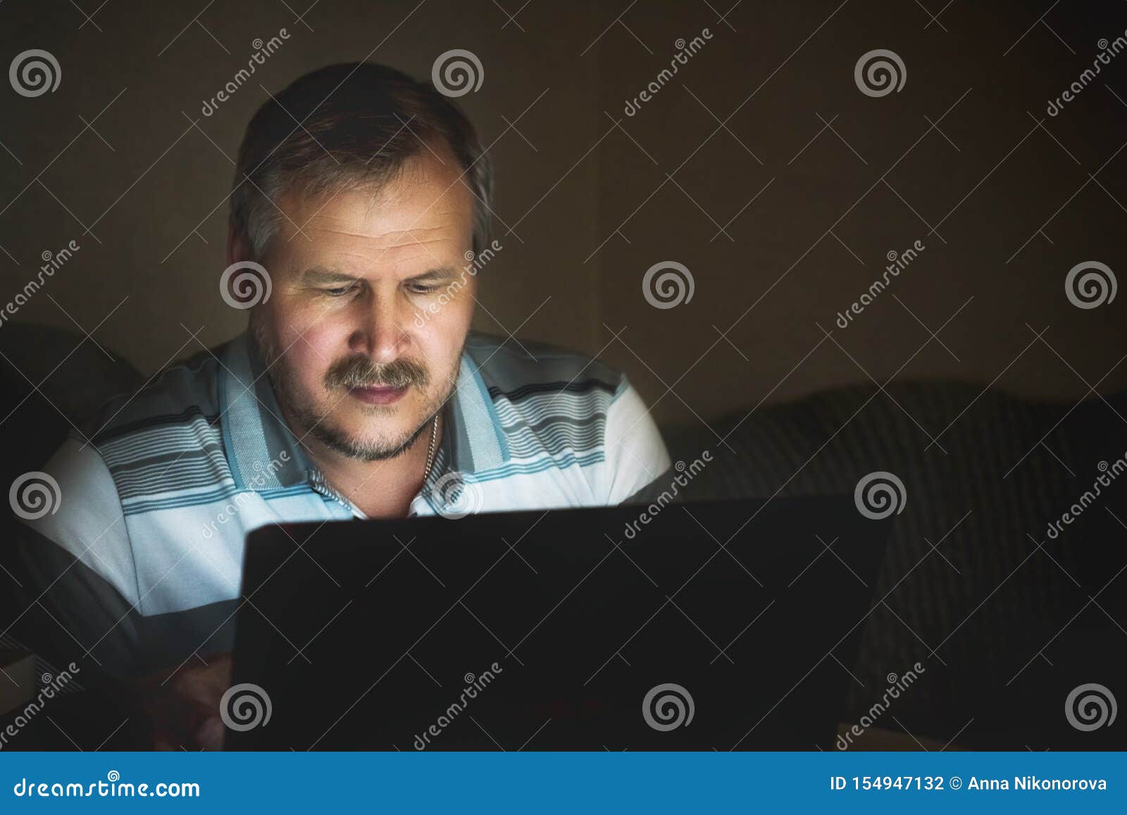 Single Man Watching Online Content on a Laptop at Night Stock Photo ...