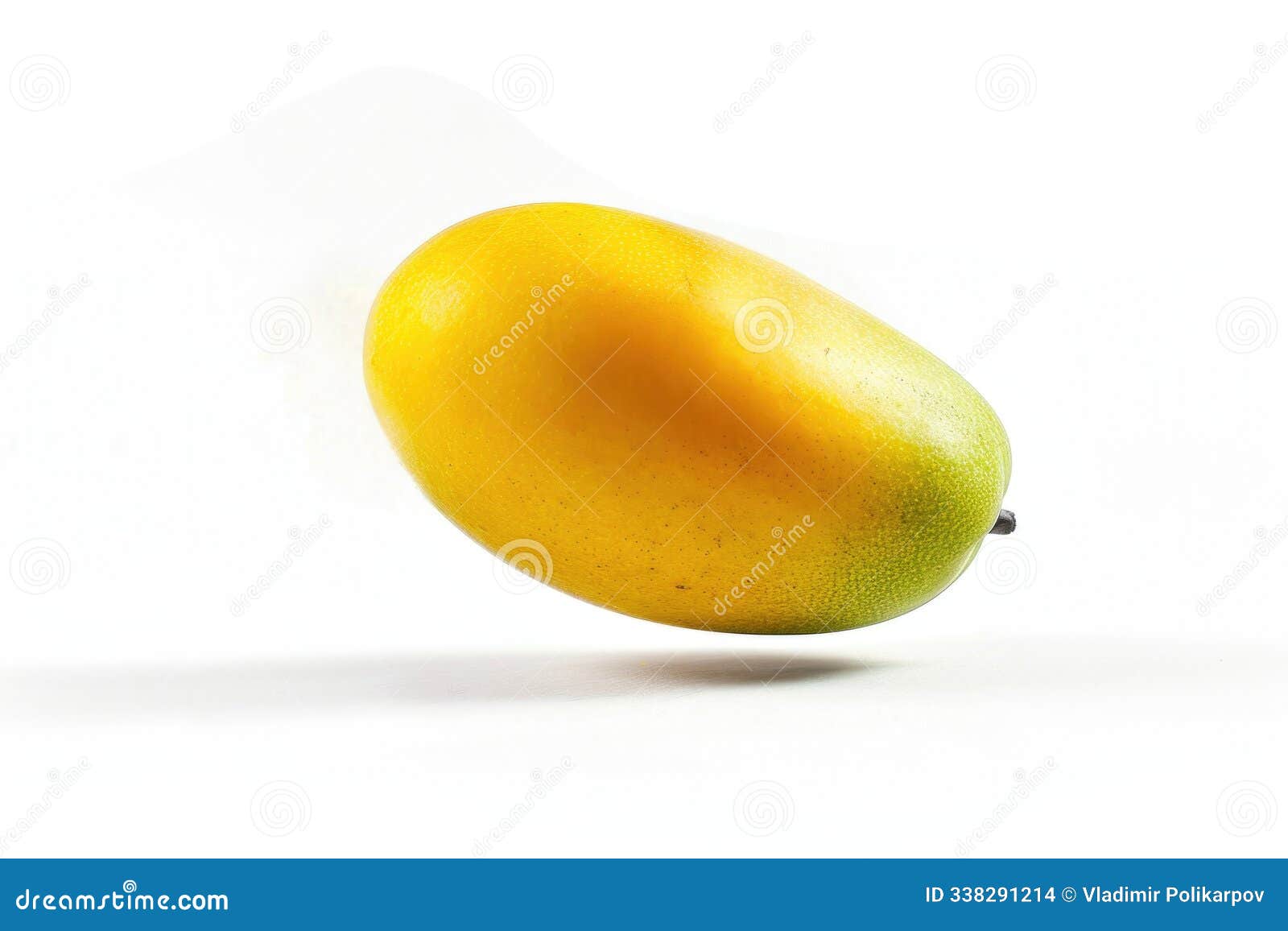 A Single Mango Fruit Sitting on a White Surface with a Subtle Shadow ...