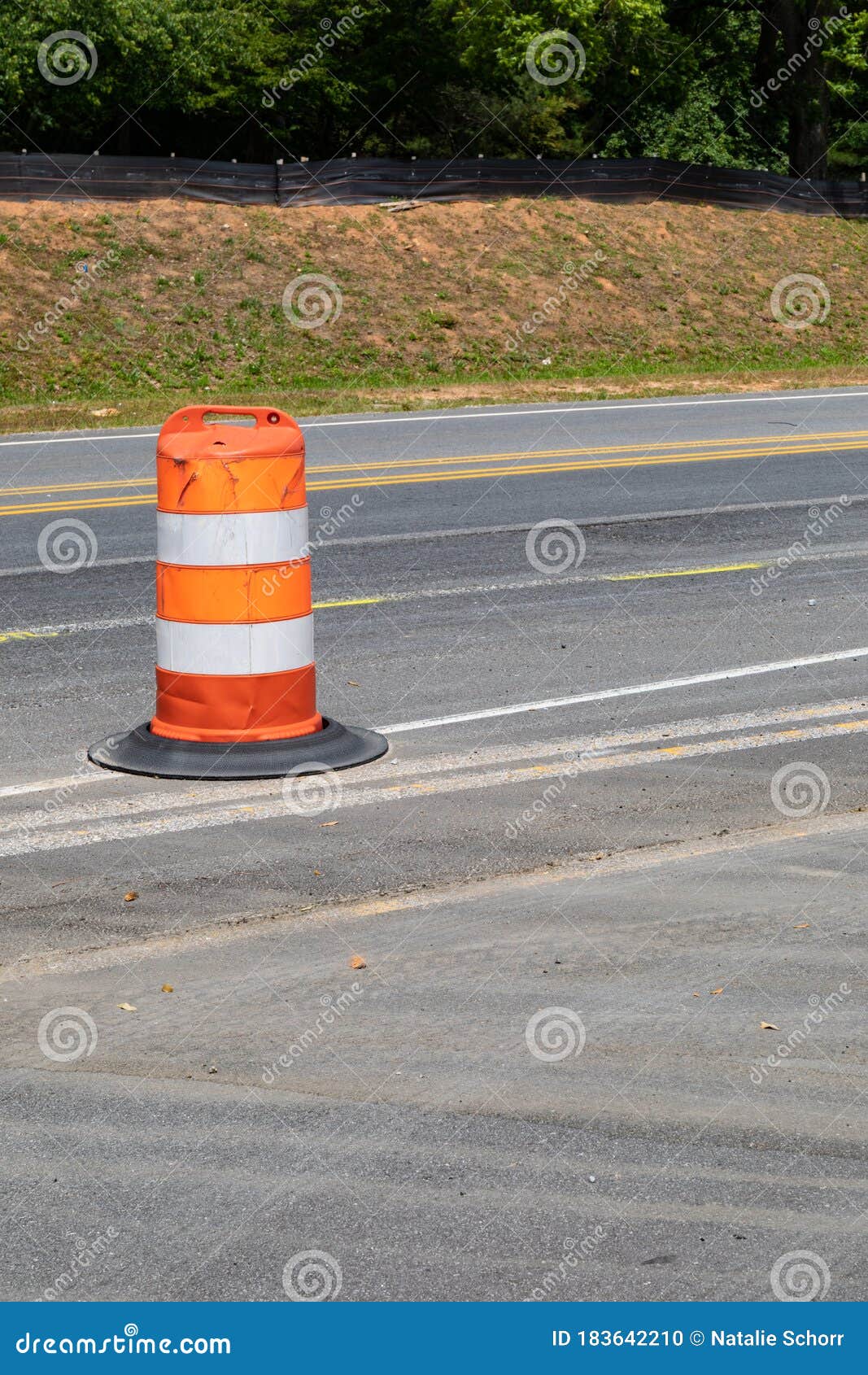 Single Orange and White Plastic Traffic Barrel Dividing a Multi Lane ...