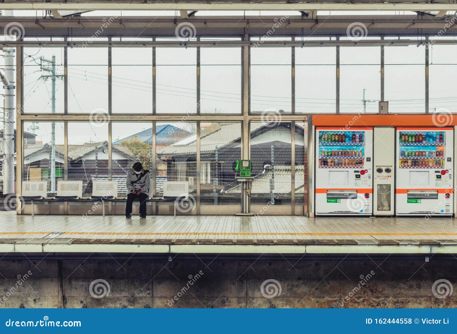 A Lone Waiting on an Empty Platform Track for the Next Train in Japan ...