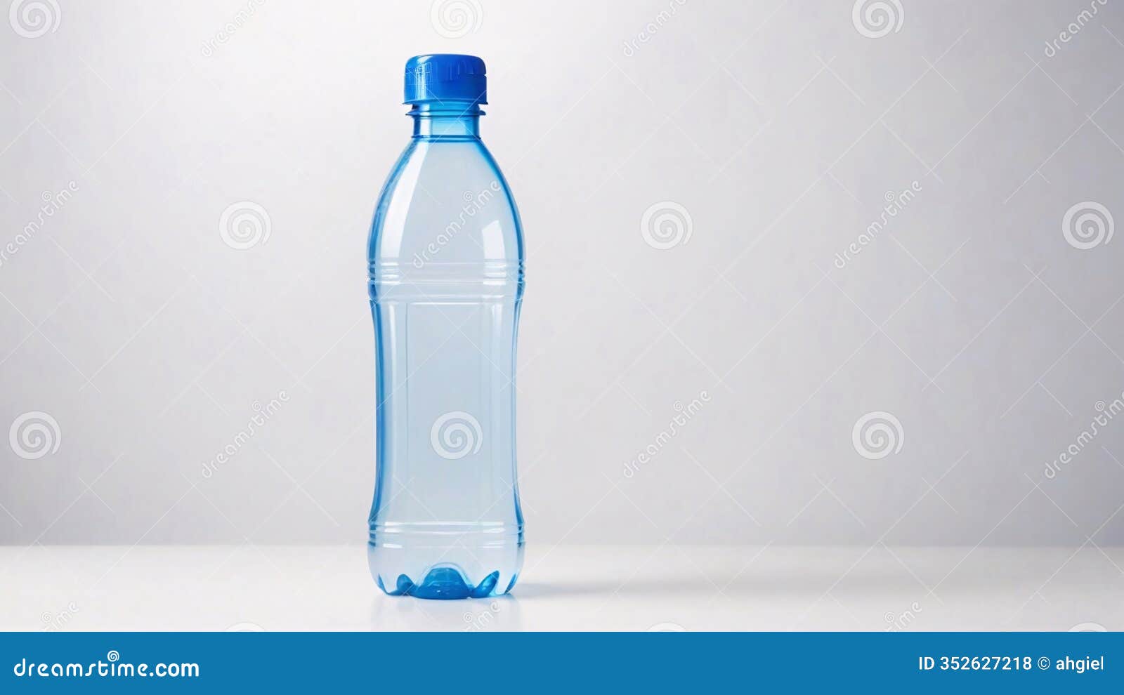 A Single Plastic Bottle of Water with a Blue Cap Stands on a White ...