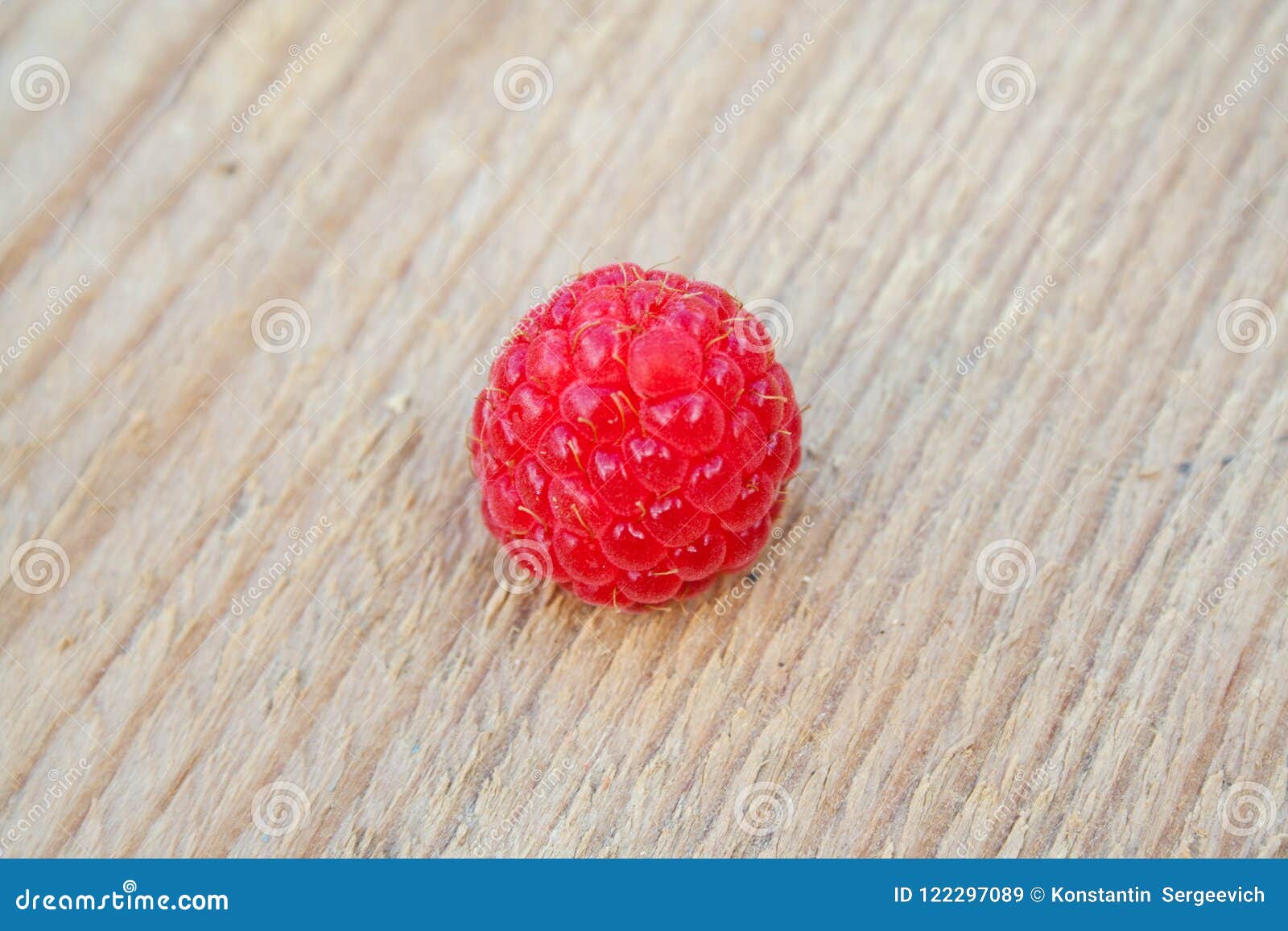 Single raspberry on wood stock image. Image of focus - 122297089