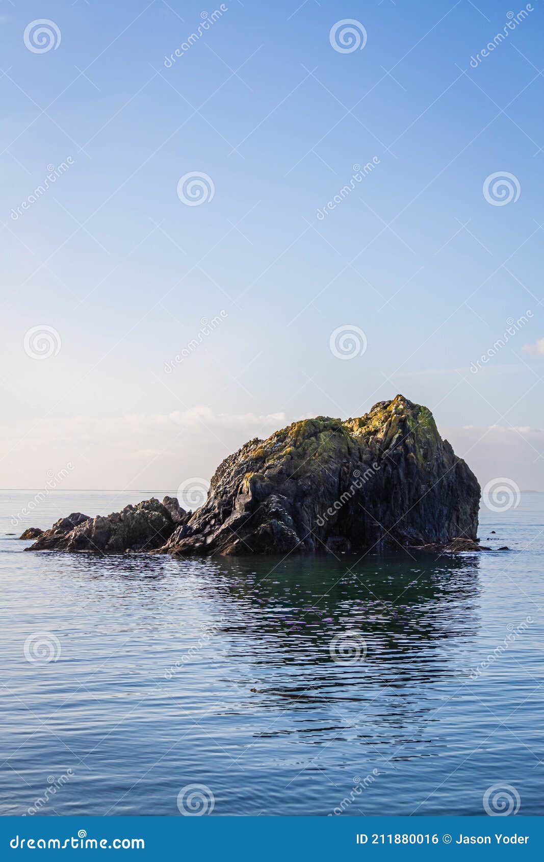 A Single Rock Protruding from the Surrounding Blue Ocean Stock Photo ...